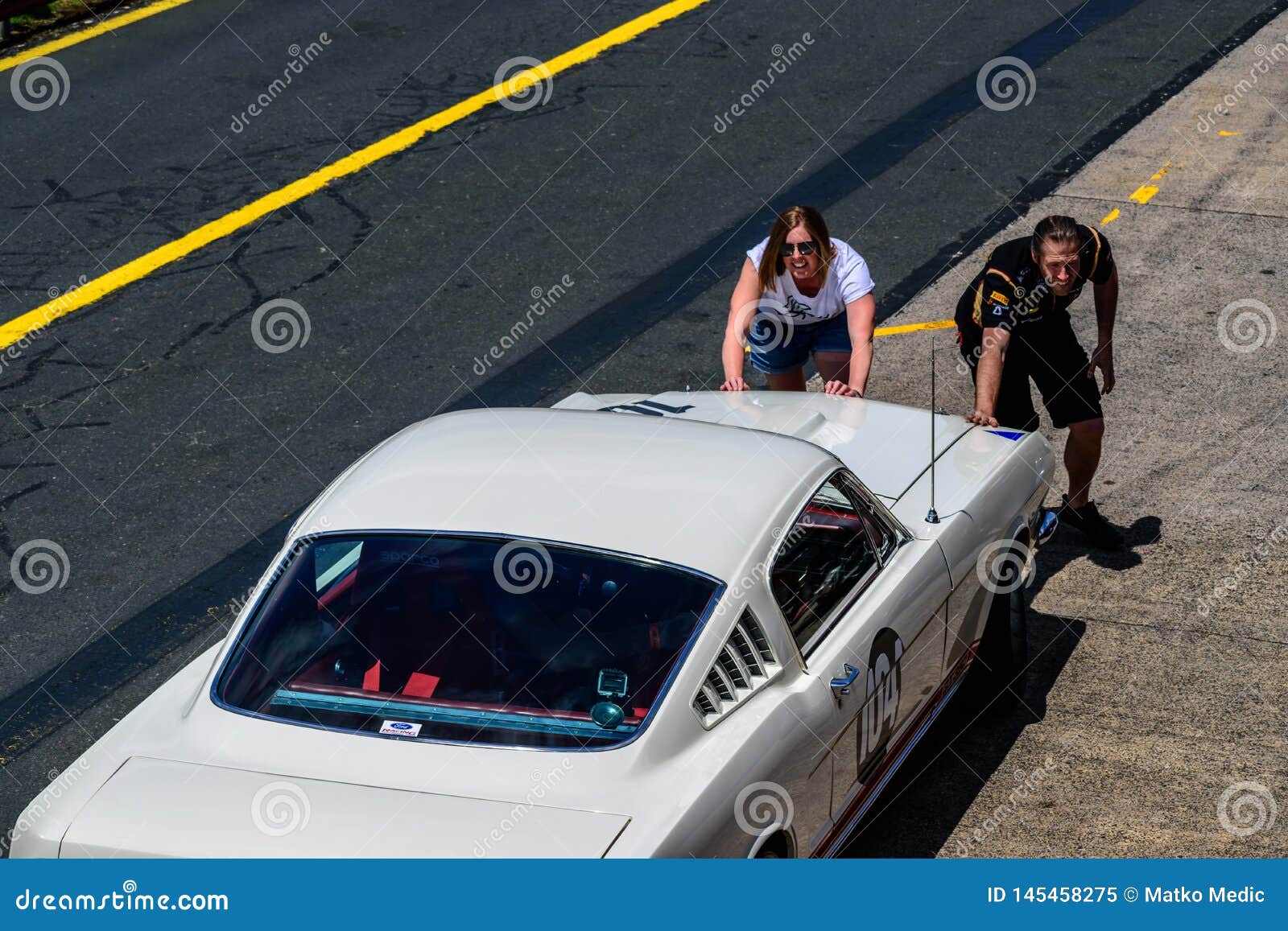 Young Woman and Man are Pushing the Racing Car Editorial Image - Image ...