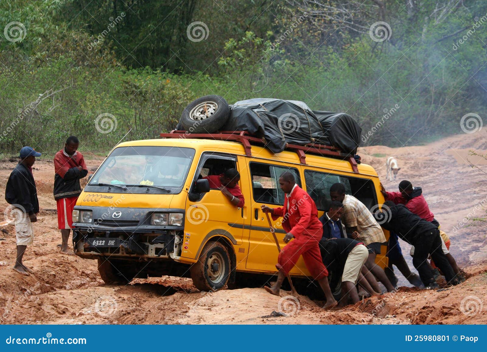 Two Men Pushing Stuck Hyundai Solaris Car Through A Snowy Yard Between ...