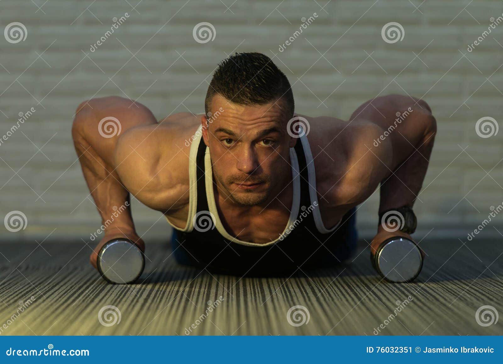 Pushups with Dumbbells stock image. Image of attractive - 76032351