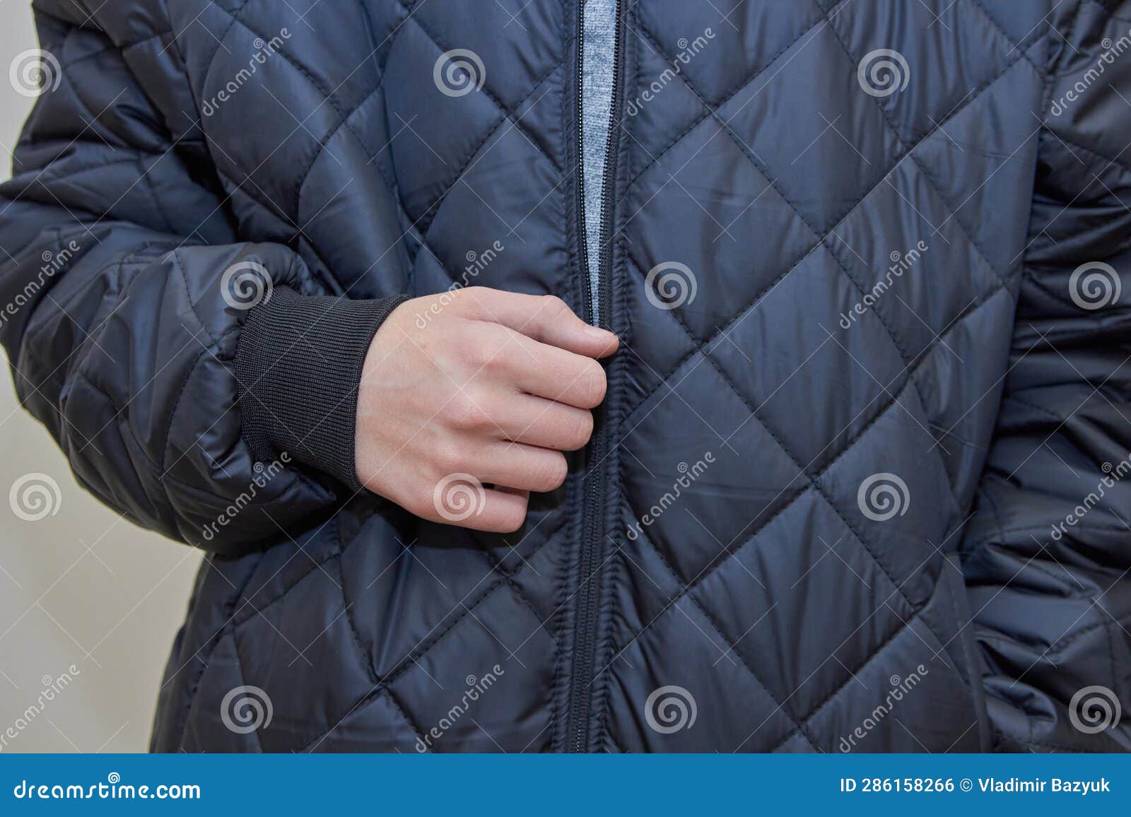 Put on a Jacket,the Boy Puts on a Black Jacket, Fastens the Zipper ...