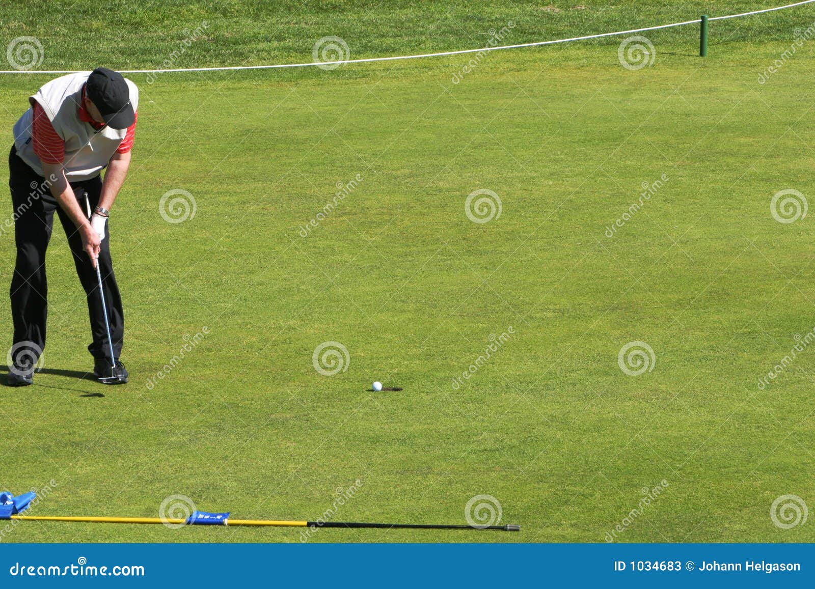 Putting it in stock image. Image of outdoors, golfcourse - 1034683