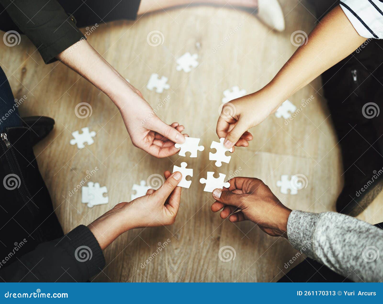 Putting All the Pieces Together. a Group of Unrecognizable People ...