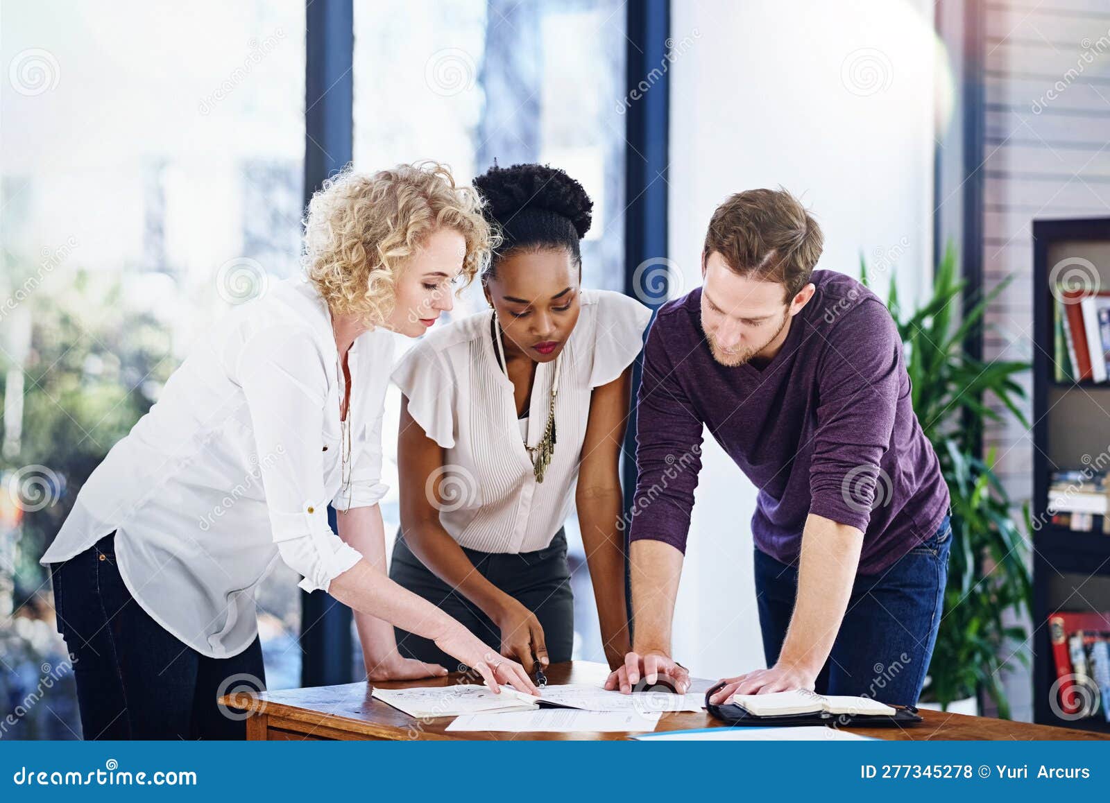 Putting All Their Creative Ideas Together. a Team of Designers Working ...