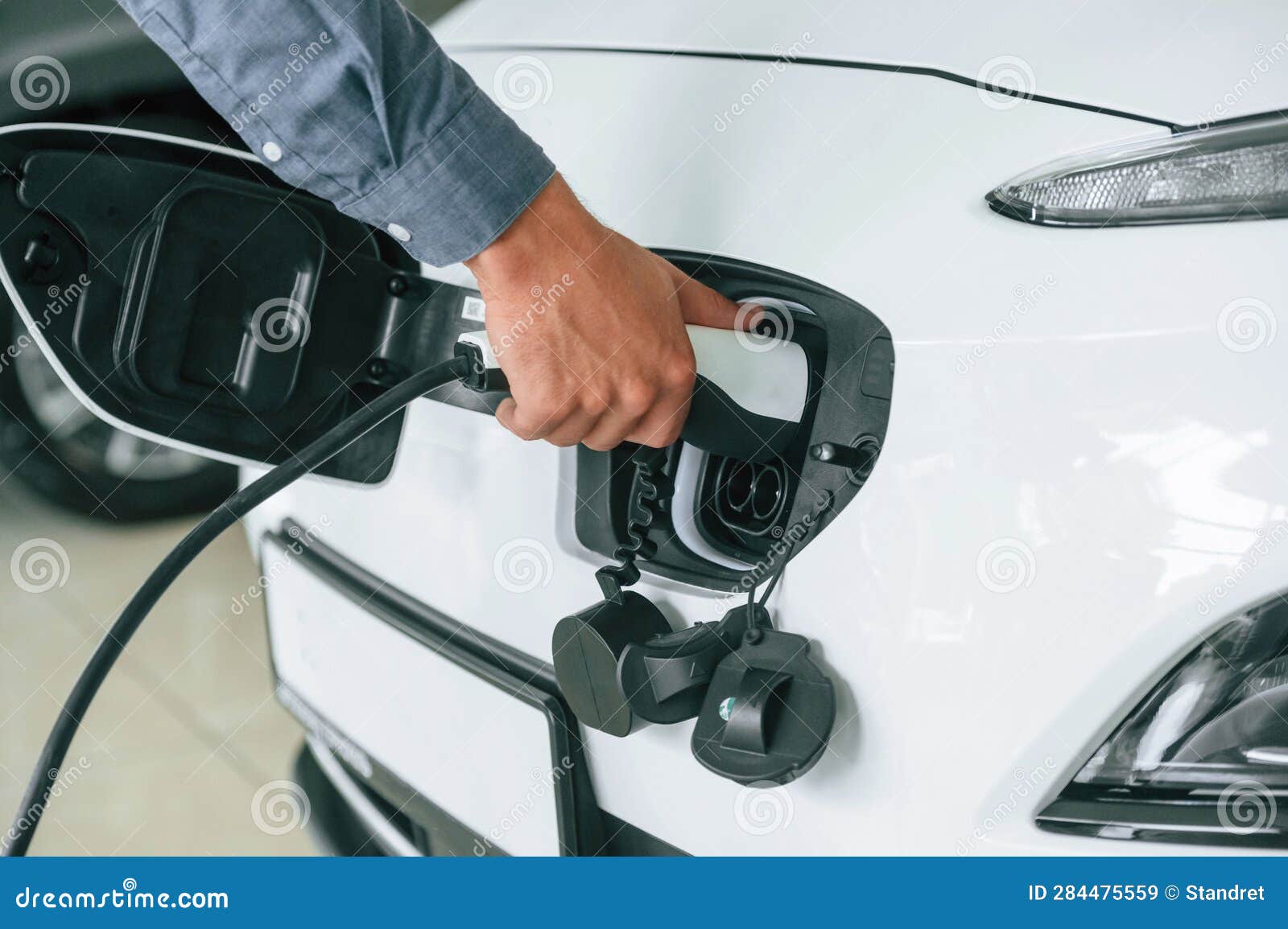 Putting Charger into Electrical Car Socket. Close Up View of Man Stock ...