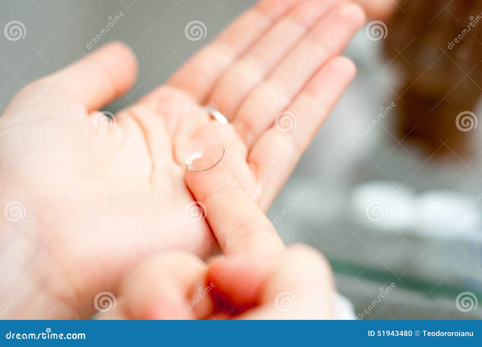 Putting on a contact lense stock photo. Image of container - 51943480