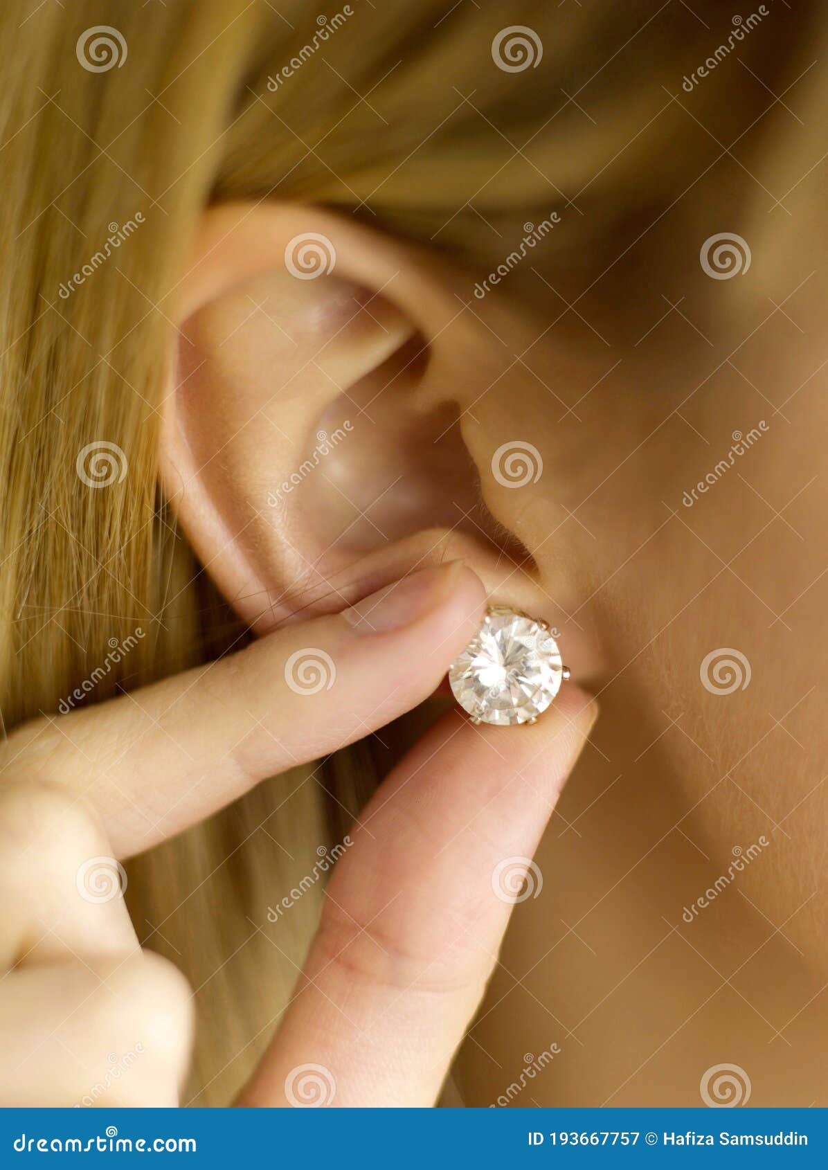 Putting on an Earring. Conceptual Image Shot Stock Image - Image of ...