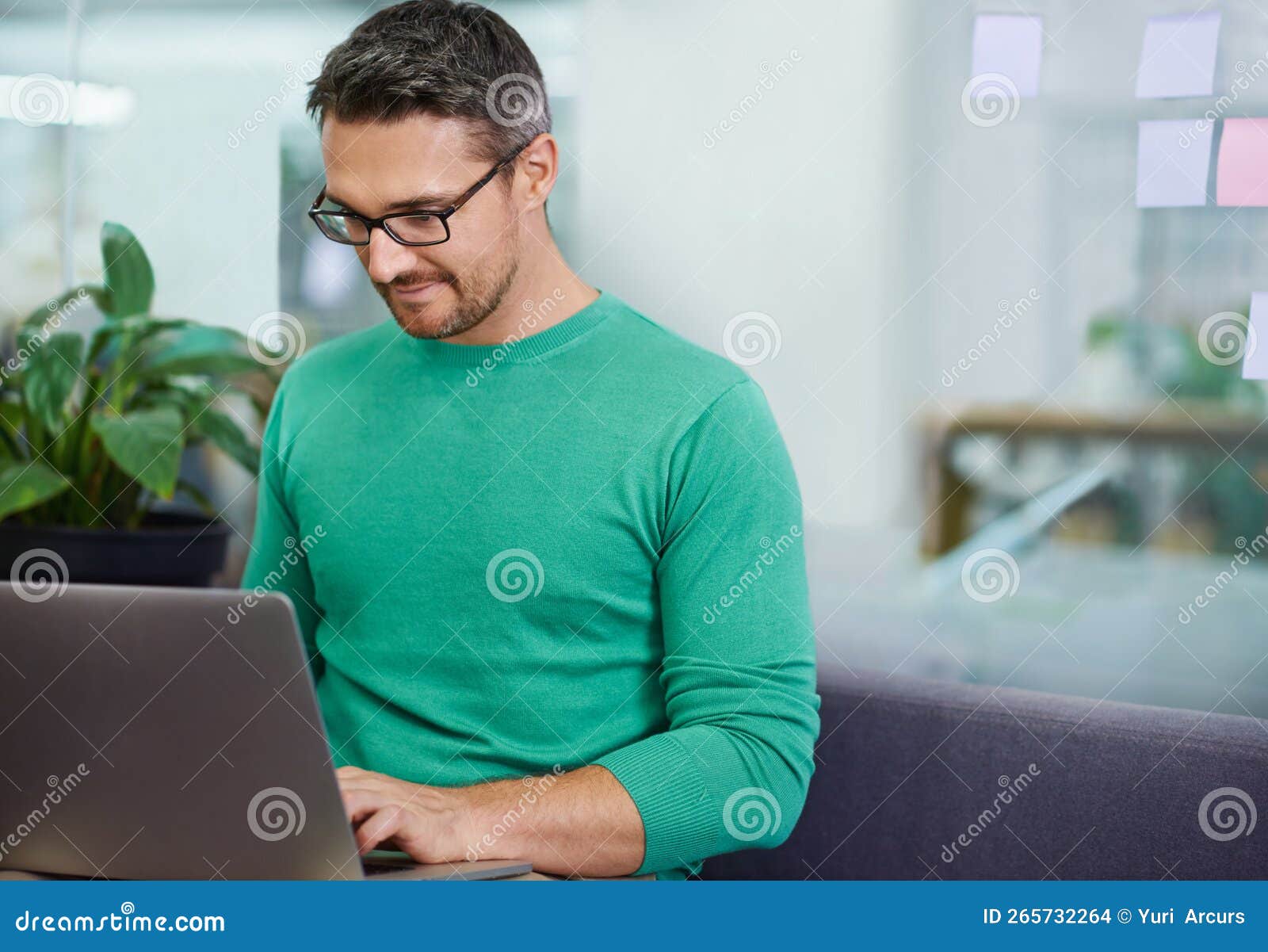 Putting in Extra Hours at Work. a Handsome Man Working on His Laptop ...
