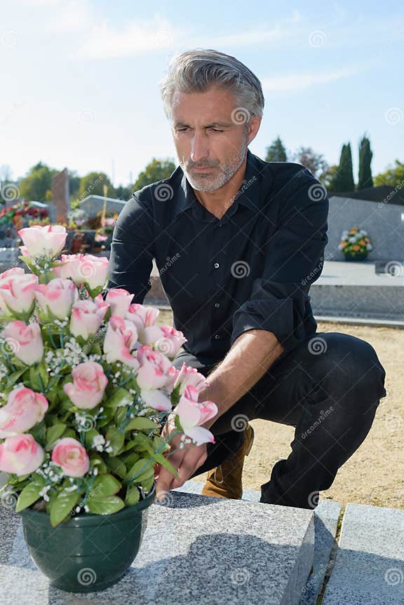 Putting flowers on grave stock image. Image of carnations - 101437947