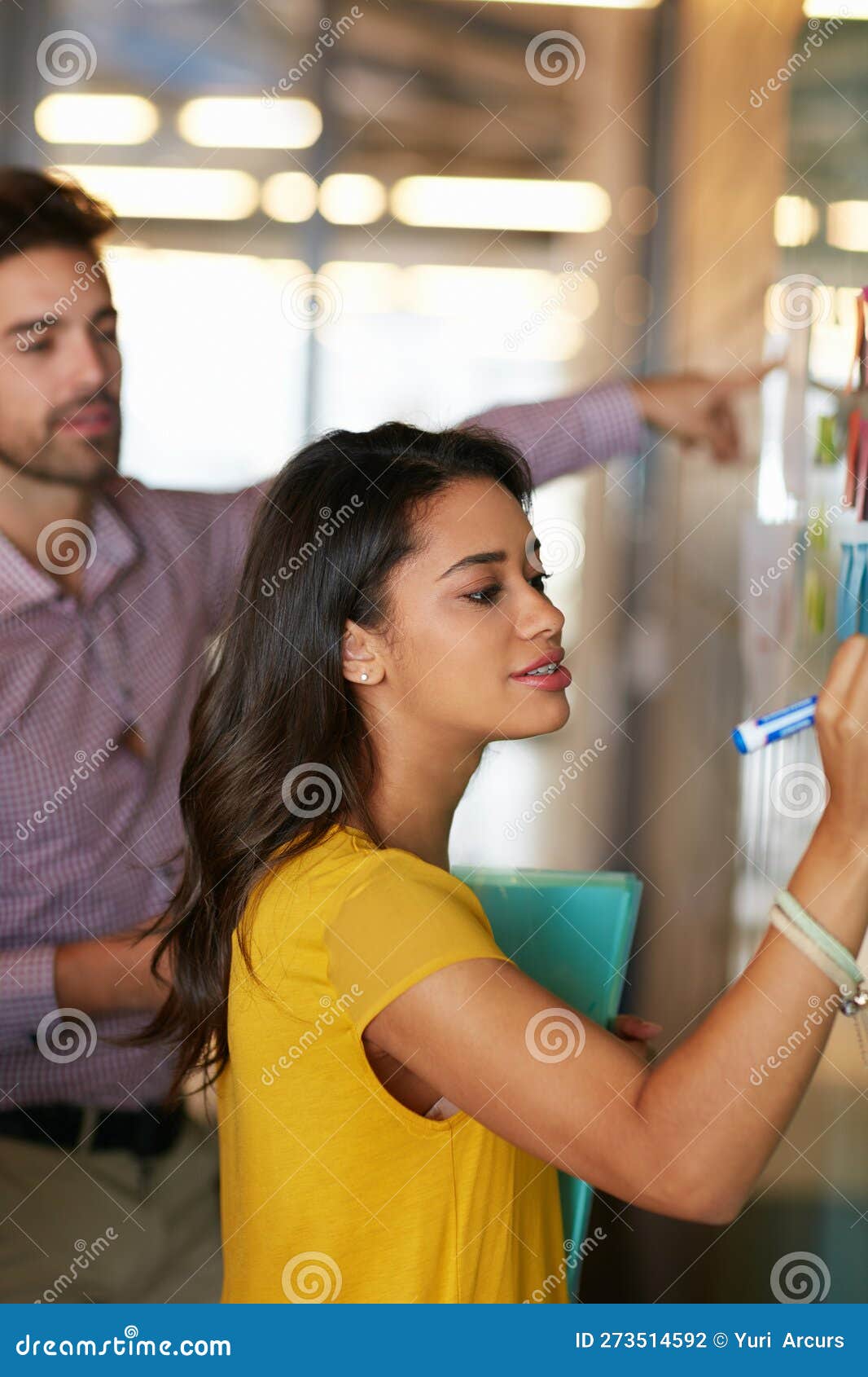 Putting Her Ideas Down on the Board. Two Businesspeople Working in the ...