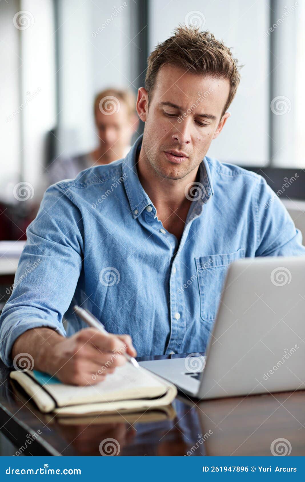 Putting His Plans into Action. a Man Writing Notes while Working on a ...