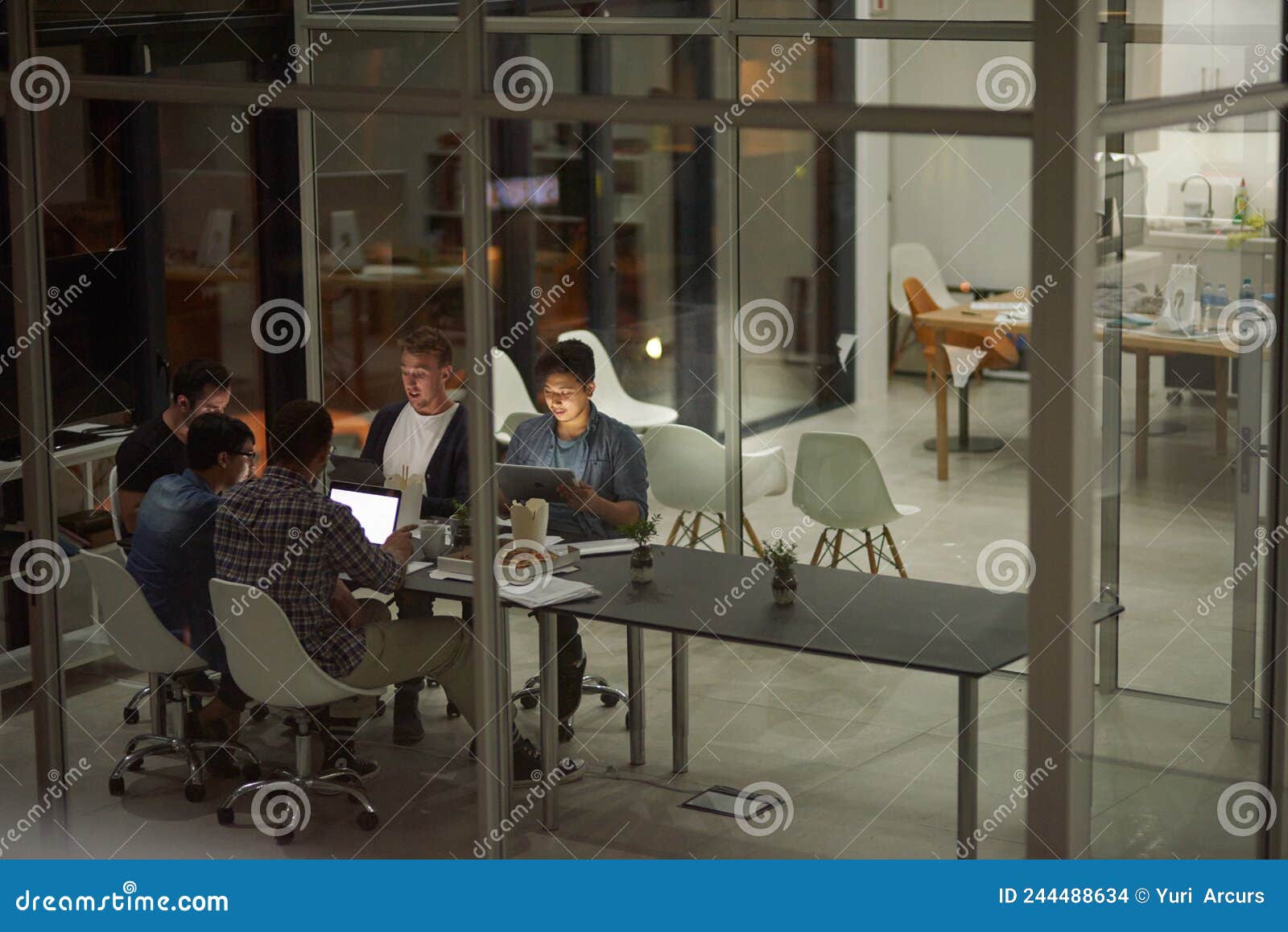 Putting in Some Extra Hours at Work. Shot of Employees Working in an ...