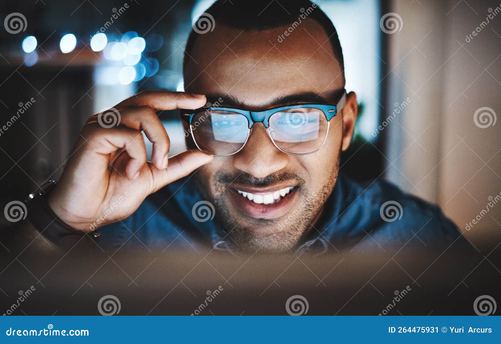 Putting in Some Overtime. a Young Businessman Using a Computer during a ...