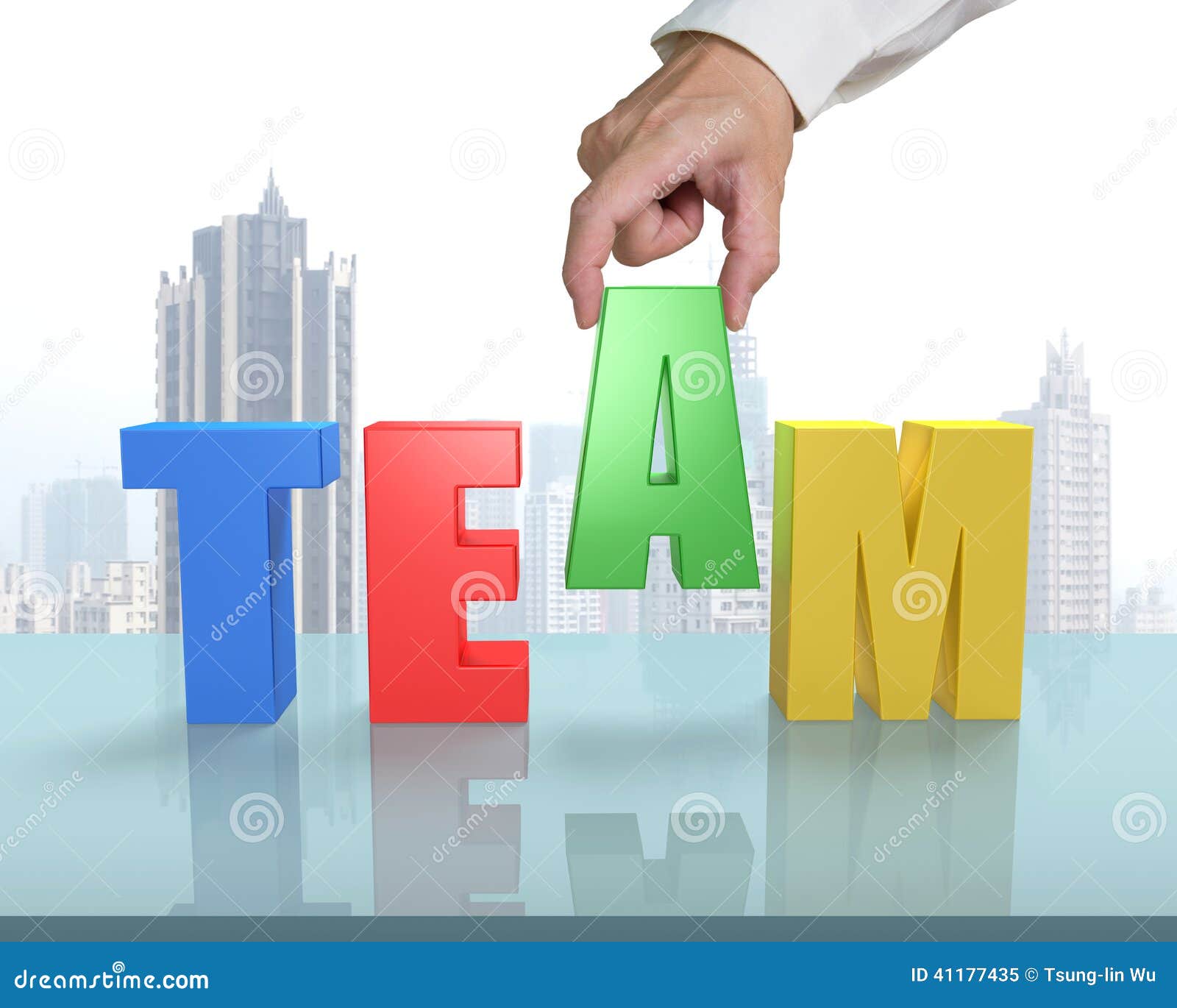 Putting a in for TEAM on Glass Table Stock Image - Image of business ...