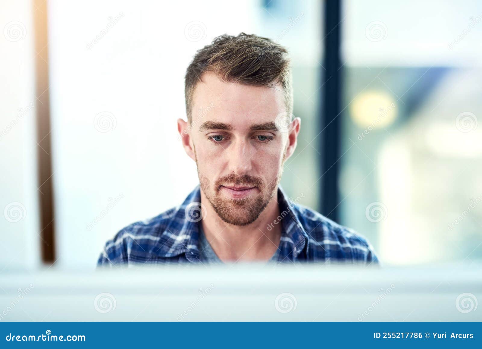 Putting the Work in. a Young Man Working in His Office. Stock Photo ...
