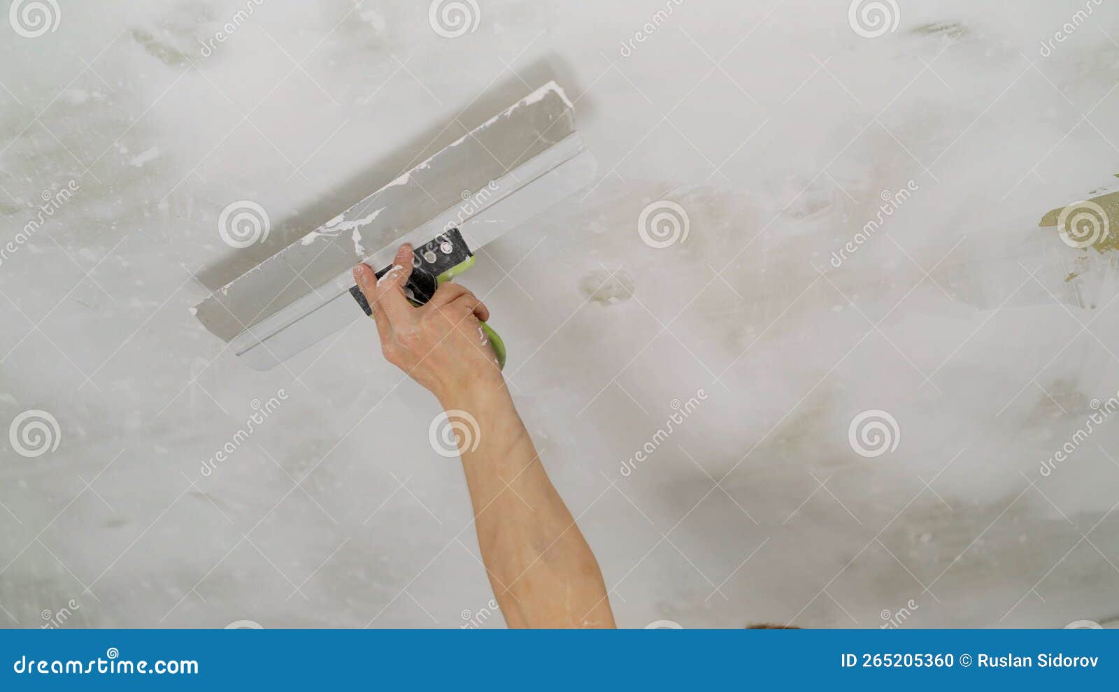 Puttying the Ceiling with a Spatula. the Master& X27;s Hands Apply ...
