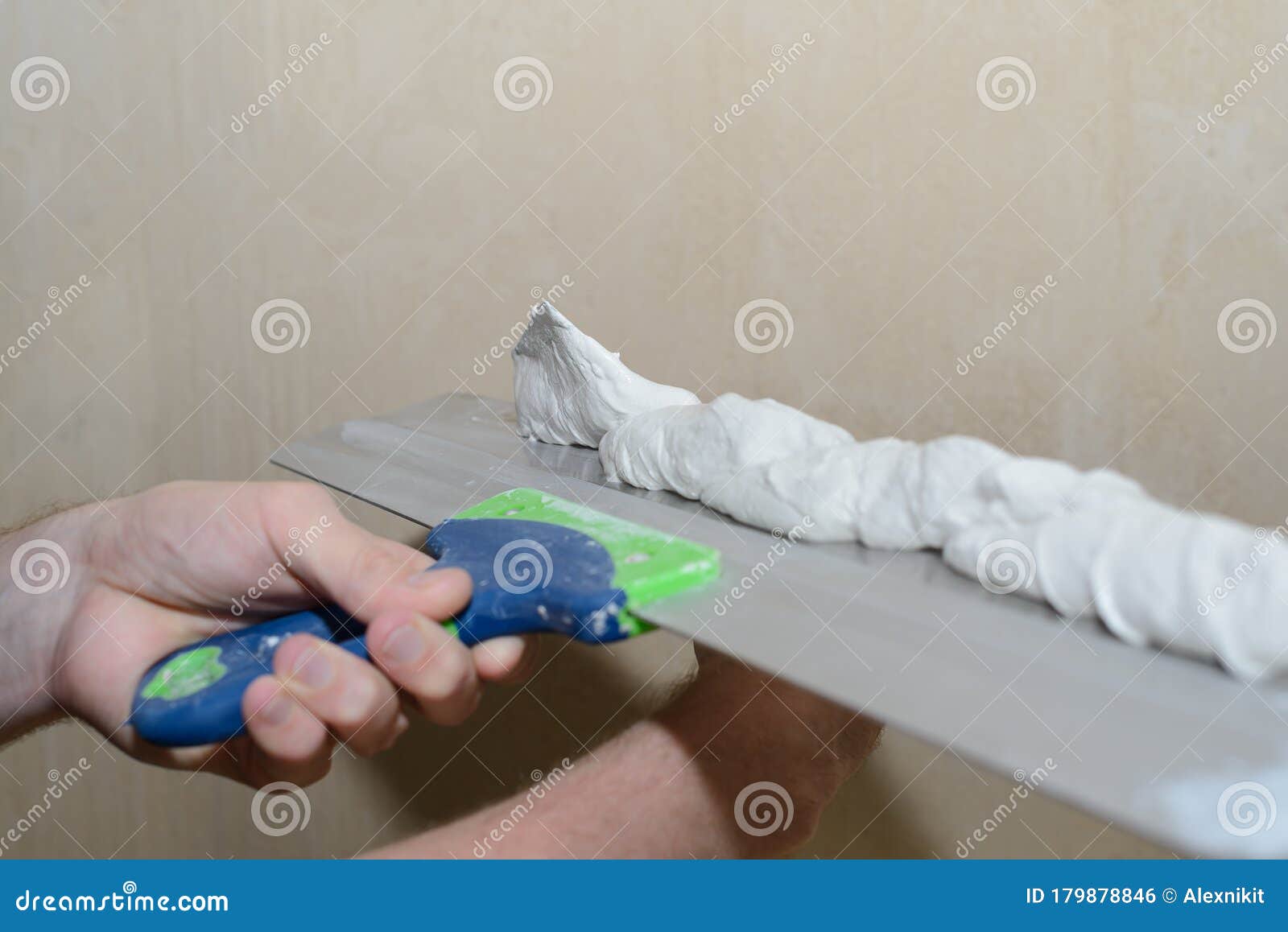 Puttying the Wall with Plaster Putty Using a Wide Spatula Stock Photo ...