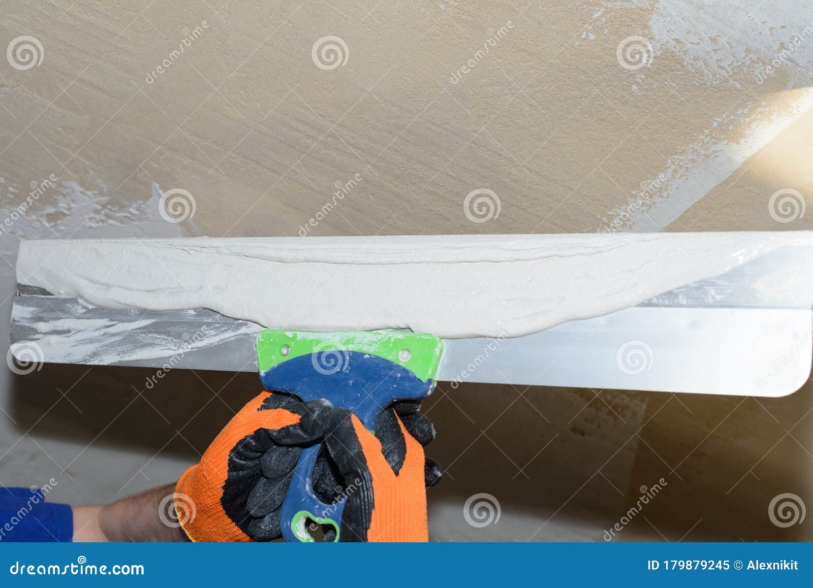 Puttying the Wall with Plaster Putty Using a Wide Spatula Stock Image ...