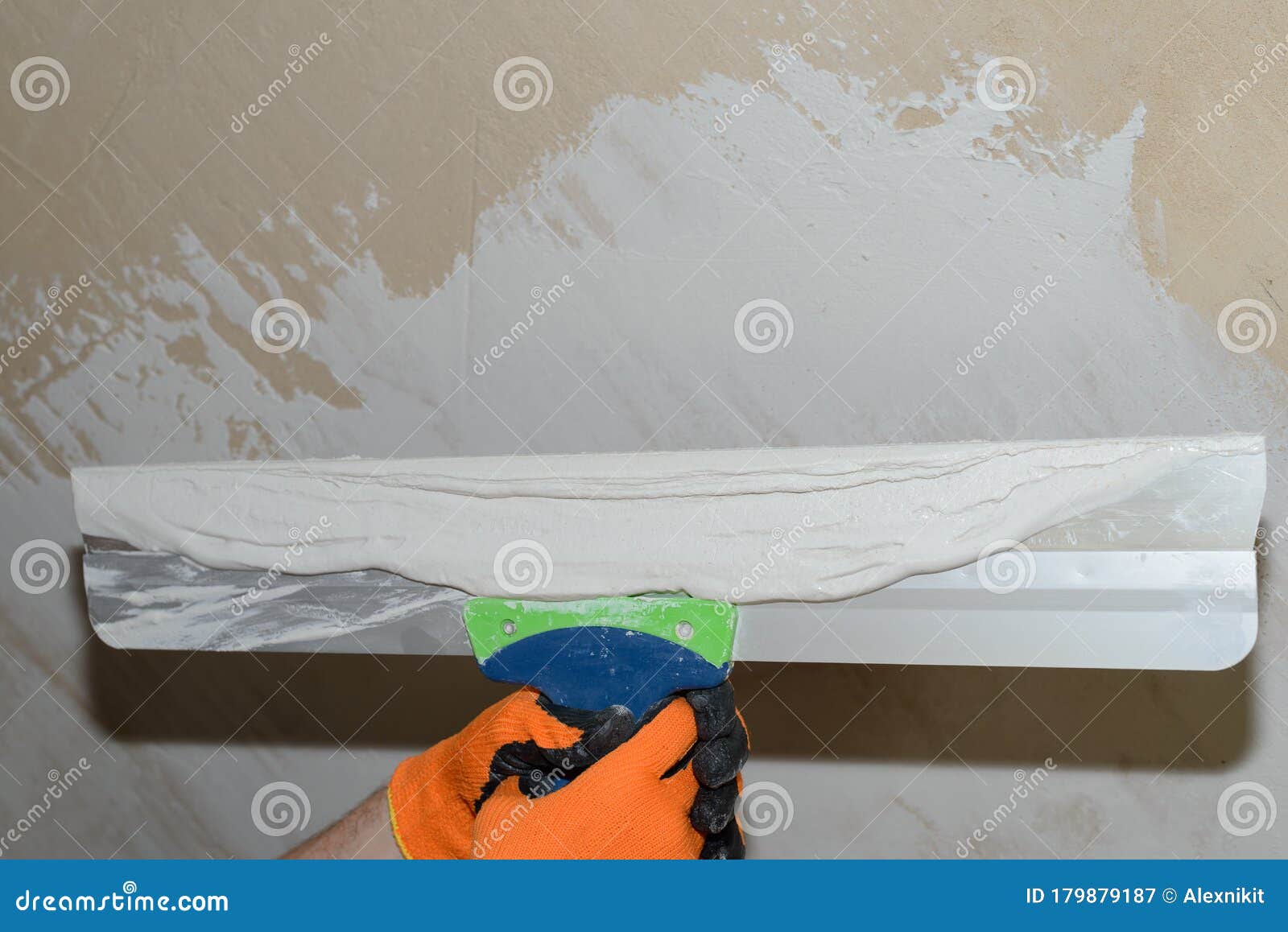 Puttying the Wall with Plaster Putty Using a Wide Spatula Stock Image ...