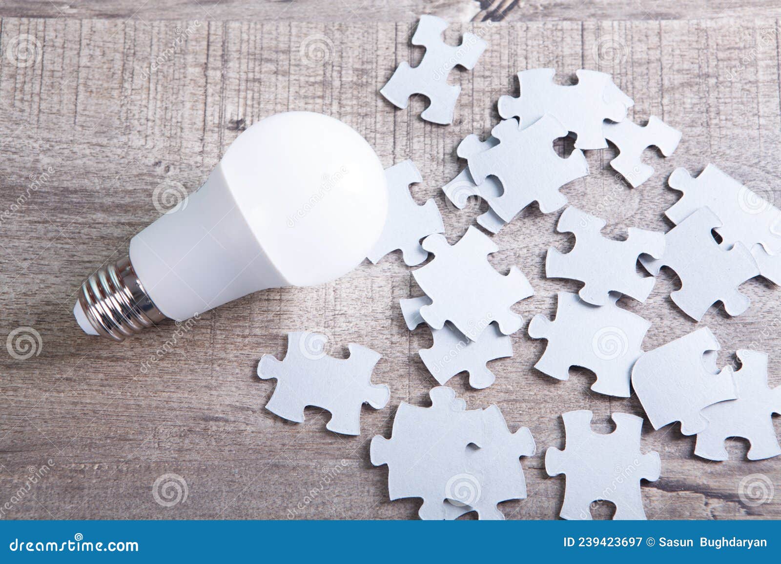 Puzzle Pieces and a Light Bulb on the Table Stock Image - Image of ...