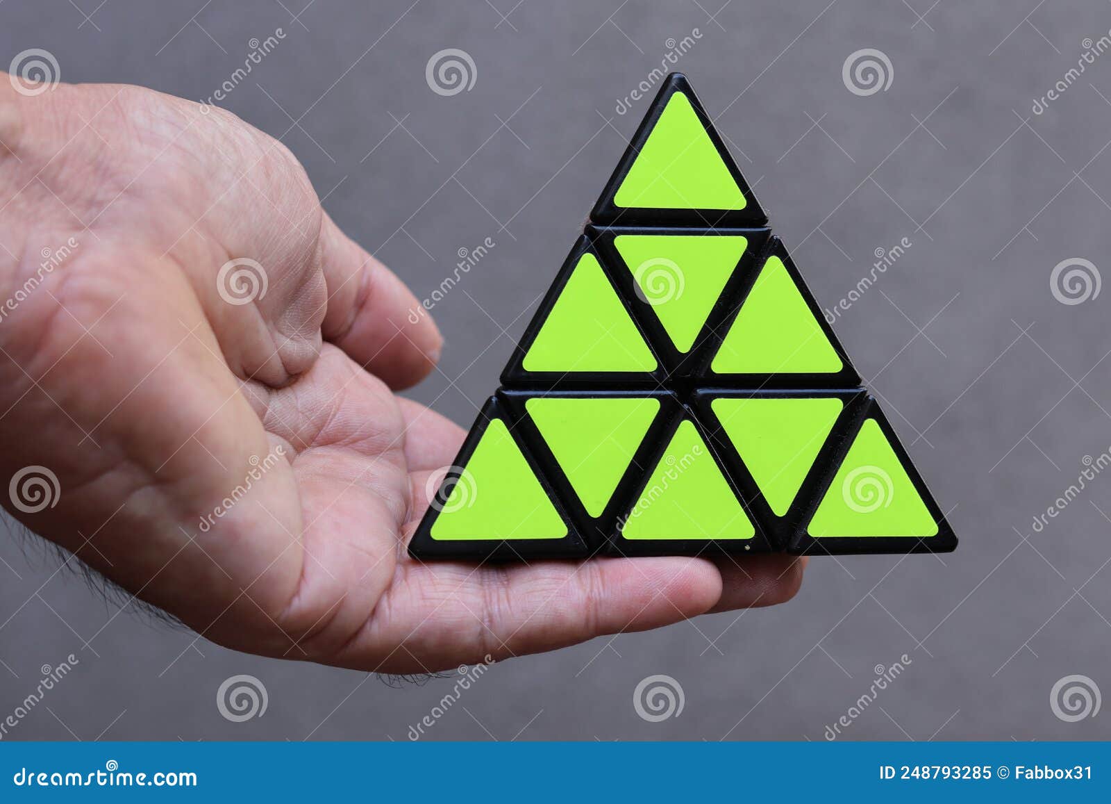 A Puzzle in the Shape of a Triangle in a Hand. Editorial Image - Image ...