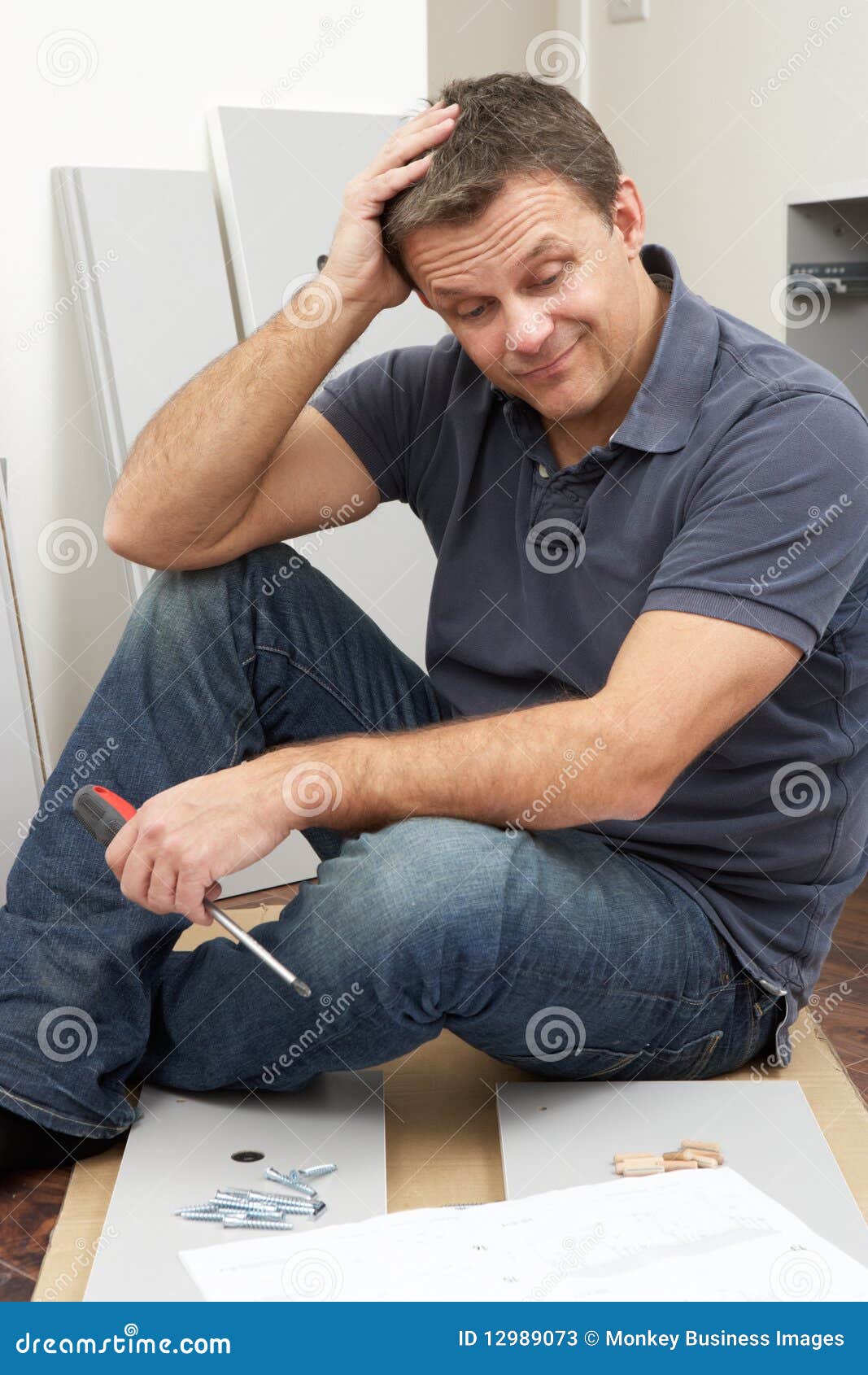 Puzzled Man Assembling Flat Pack Furniture Stock Image - Image of ...