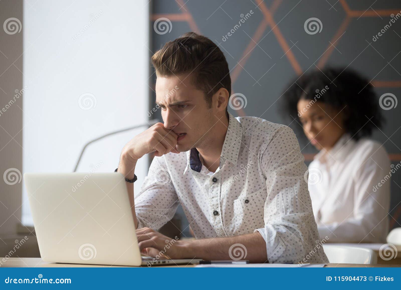 Puzzled Serious Male Employee Solving Online Laptop Problem in O Stock ...