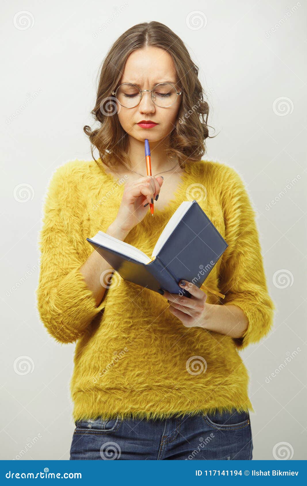 Puzzled Woman Looking at Diary with Disgruntled Expression ...