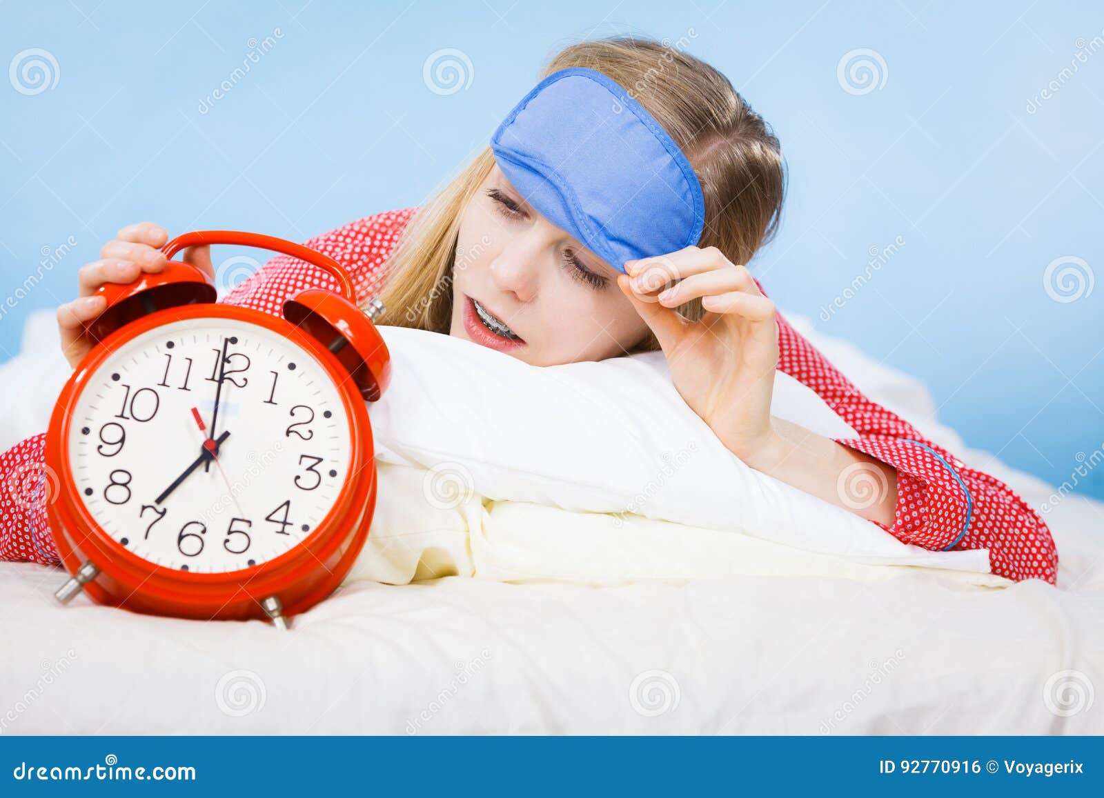 Pyjamas De Port De Femme De Sommeil Tenant Lhorloge Photo Stock