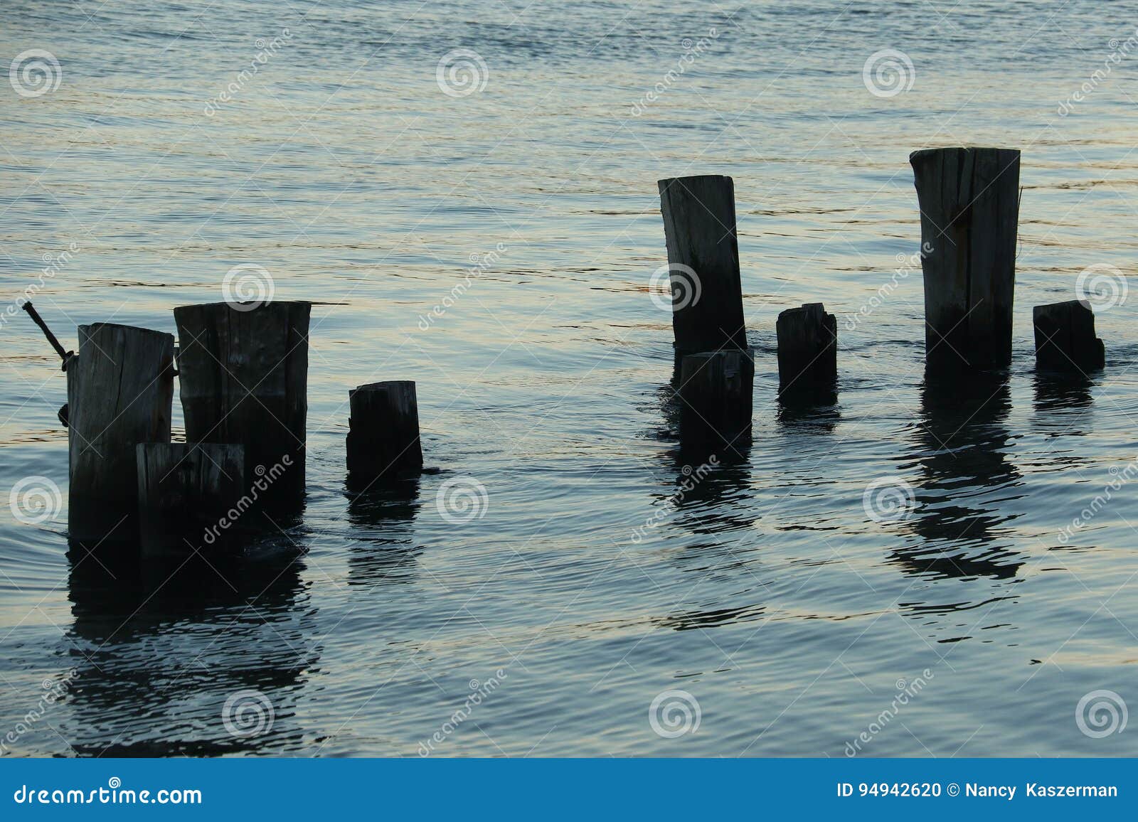 Pylons in Water at Sunset stock photo. Image of marine - 94942620