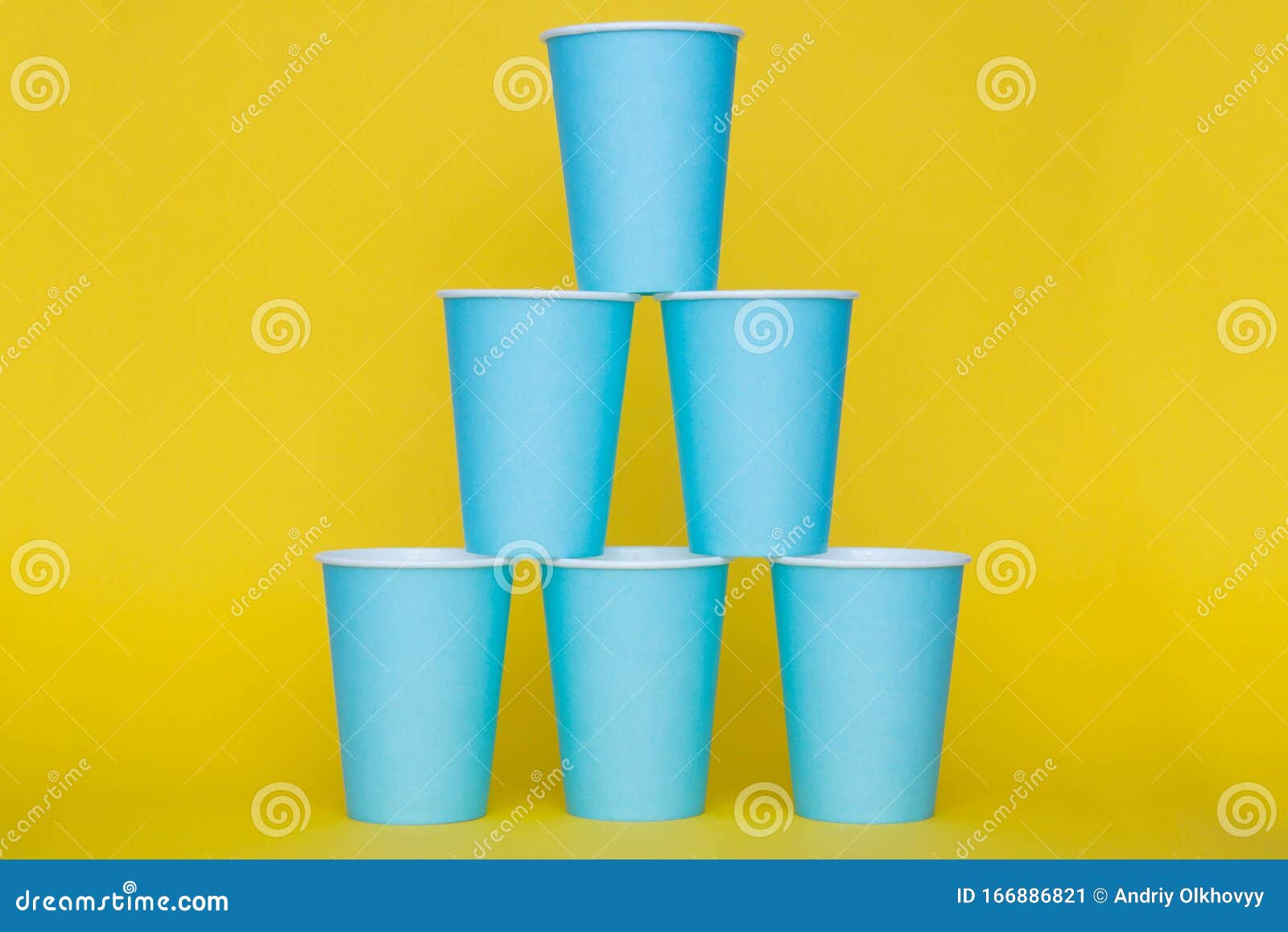 Pyramid of Blue Paper Disposable Cups on Yellow Background. Set for ...