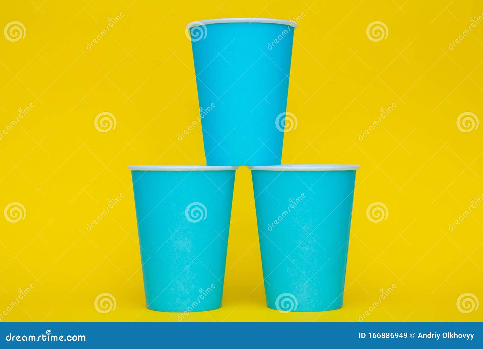 Pyramid of Blue Paper Disposable Cups on Yellow Background. Set for ...