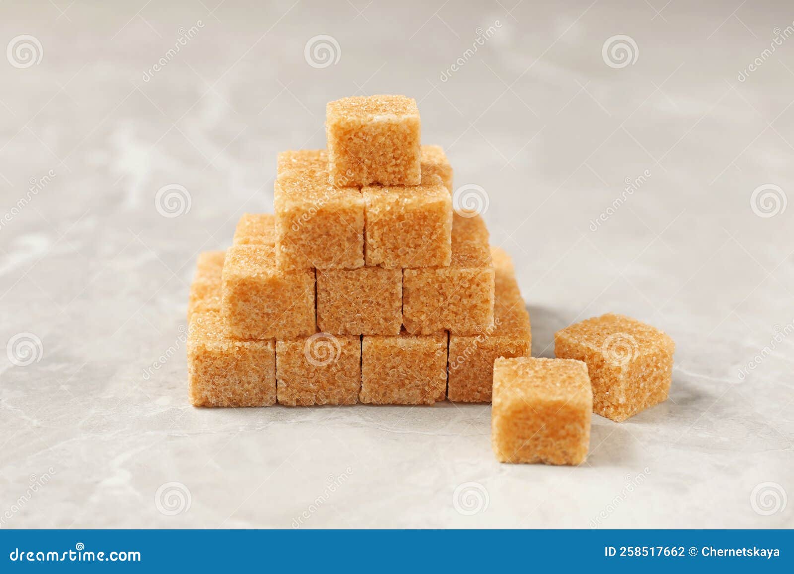 Pyramid Made of Brown Sugar Cubes on Light Grey Marble Table, Closeup ...
