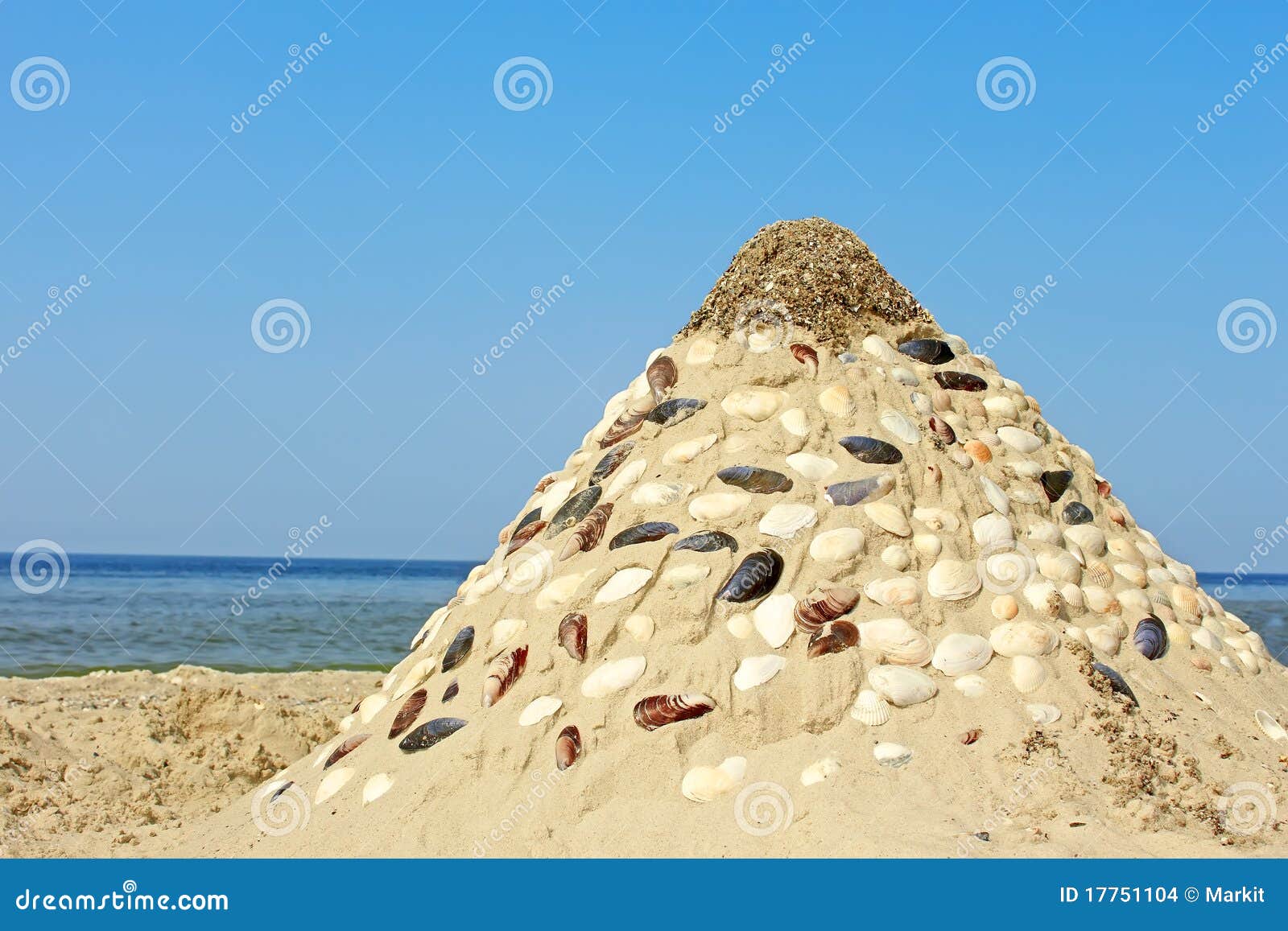 Pyramid of sand and shells stock photo. Image of blue - 17751104