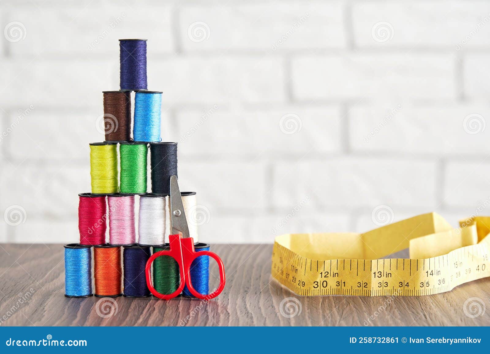 Pyramid of Spools of Multi-colored Sewing Threads, Scissors, Measuring ...