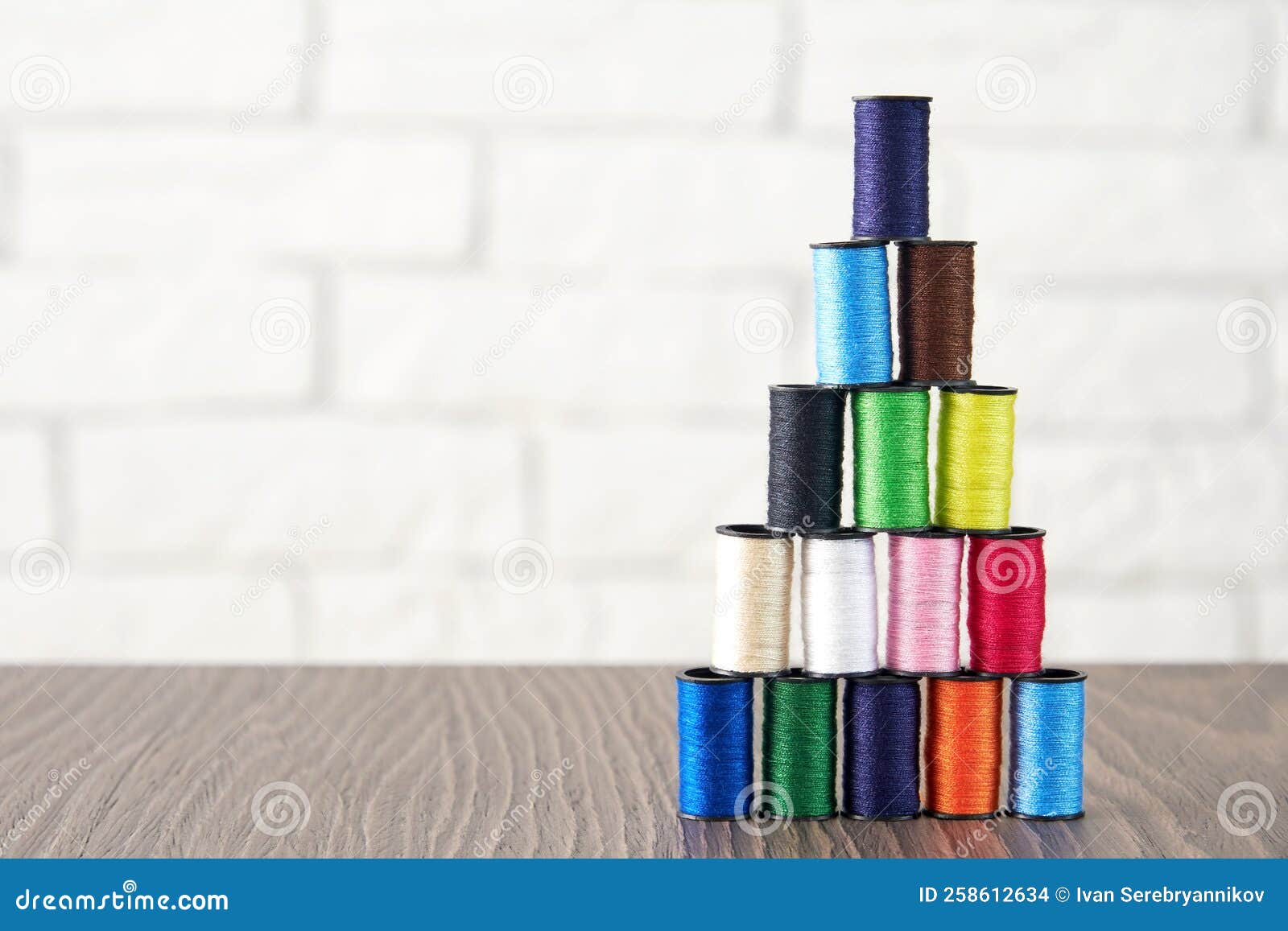 Pyramid of Spools of Multi-colored Sewing Threads on the Table Stock ...