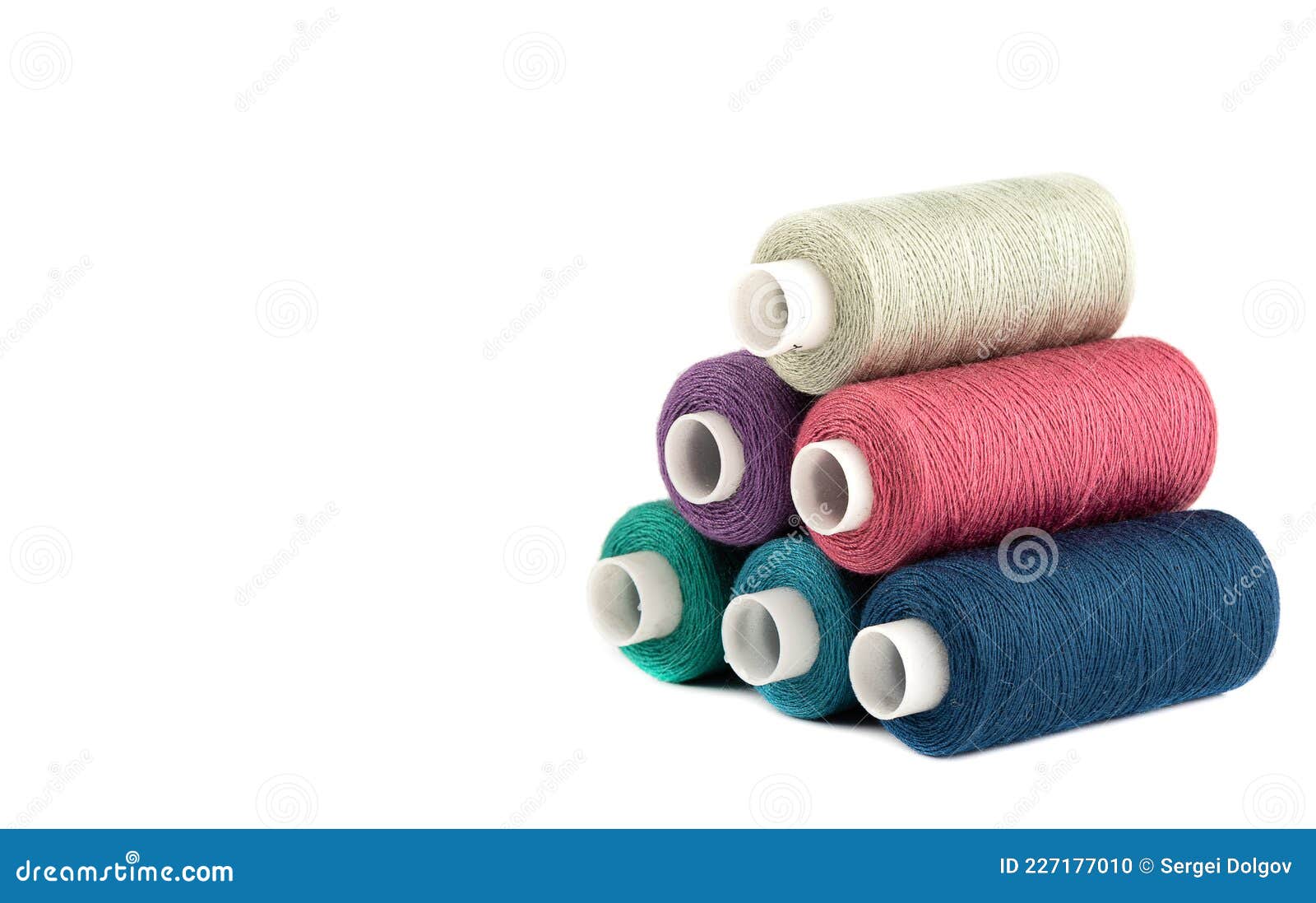 Pyramid from Spools of Threads of Different Colors on a White ...
