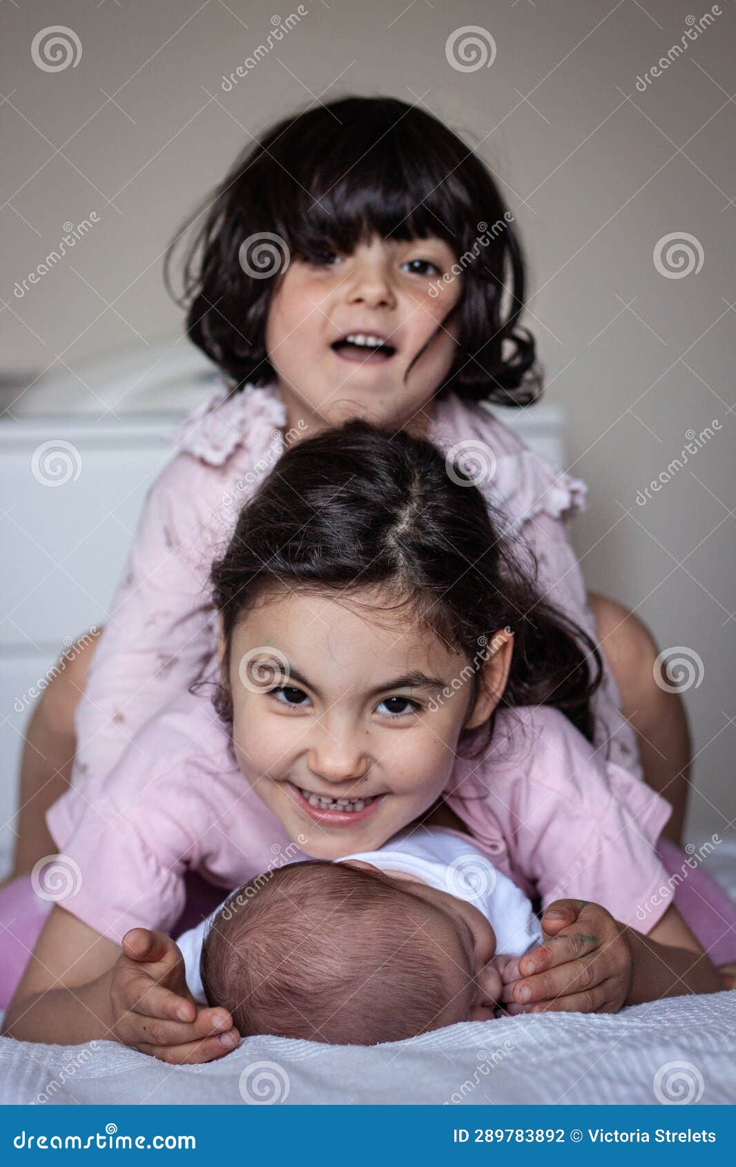 Pyramid of Three Smiling Kids Lying on Each Other Stock Photo - Image ...