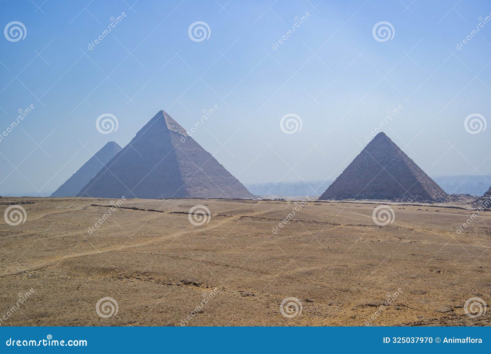 Pyramids of Giza with Blue Sky and Desert in the Foreground Stock Photo ...