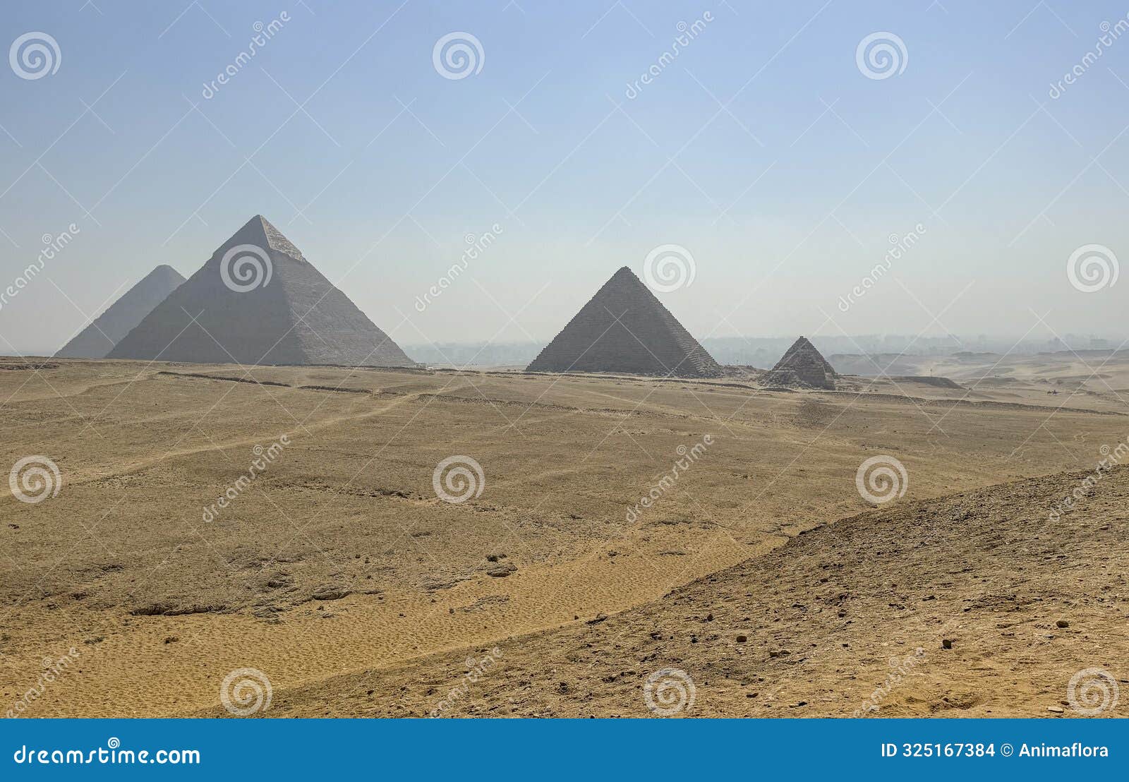 Pyramids of Giza with Blue Sky and Desert in the Foreground Stock Photo ...