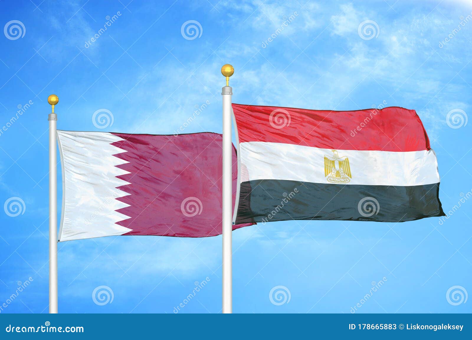 Qatar and Egypt Two Flags on Flagpoles and Blue Cloudy Sky Stock Image ...