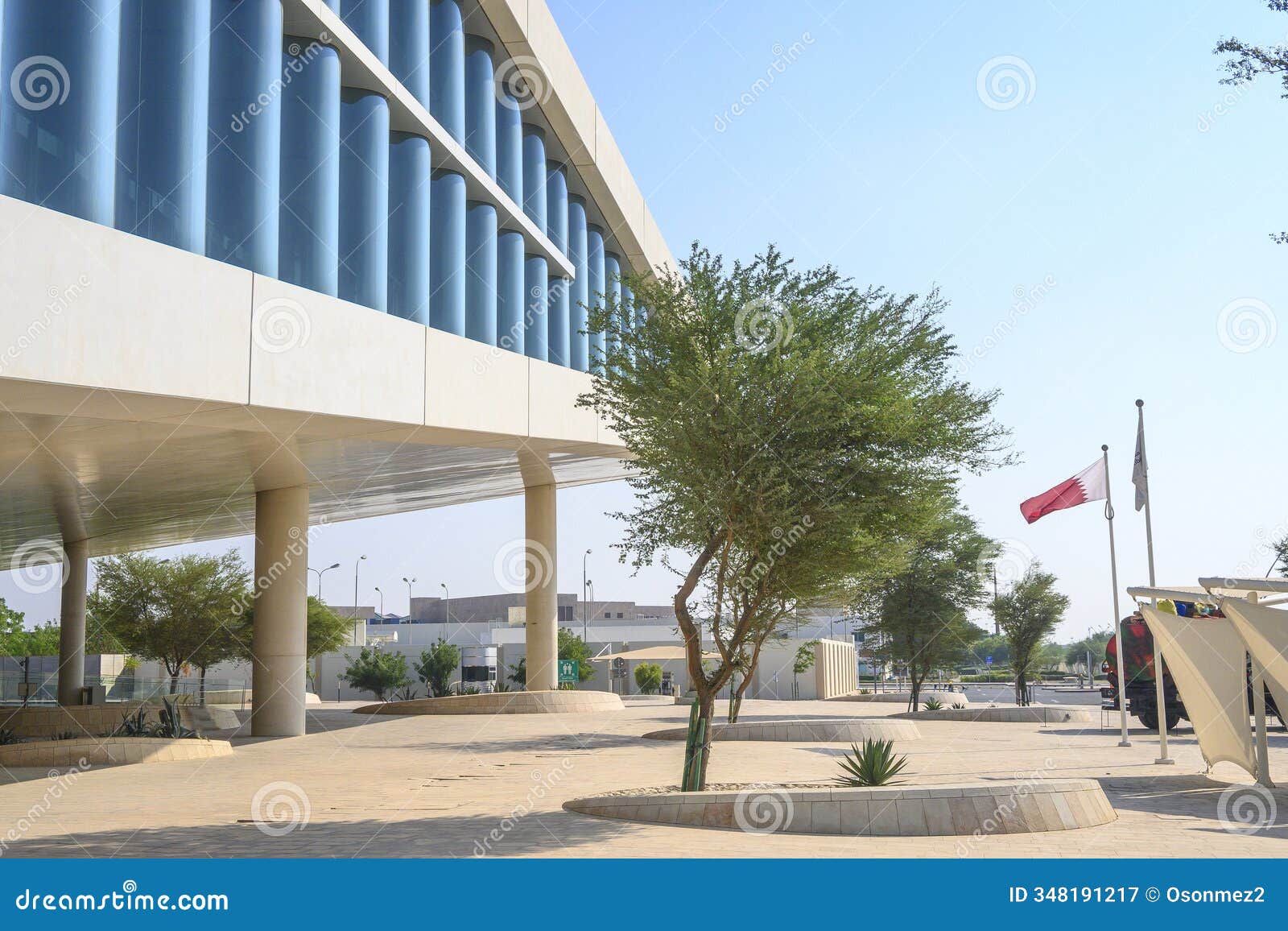 Qatar National Library in Doha with the Qatar Flag Waving Next To it ...