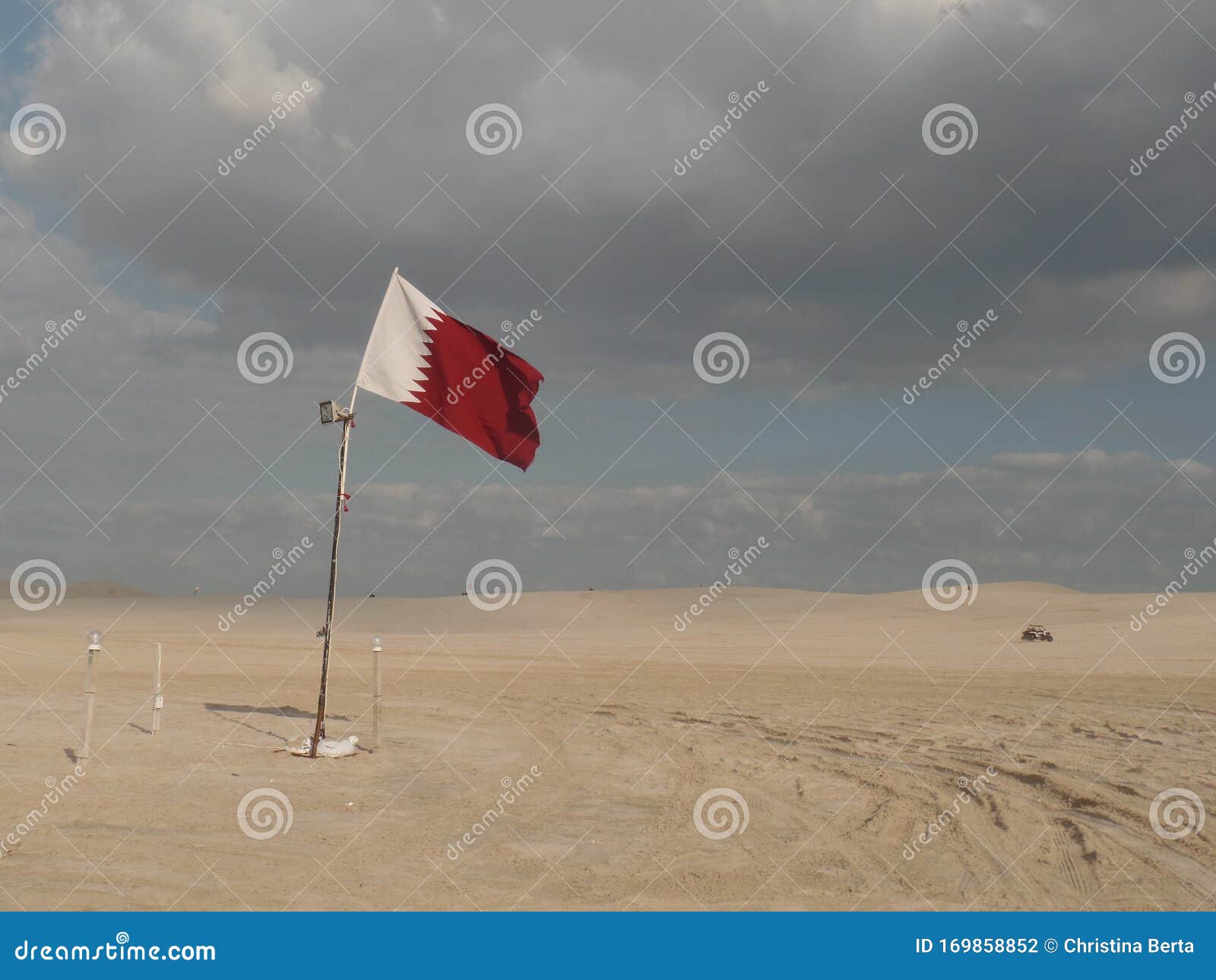 Qatari flag in the desert stock photo. Image of emblem - 169858852