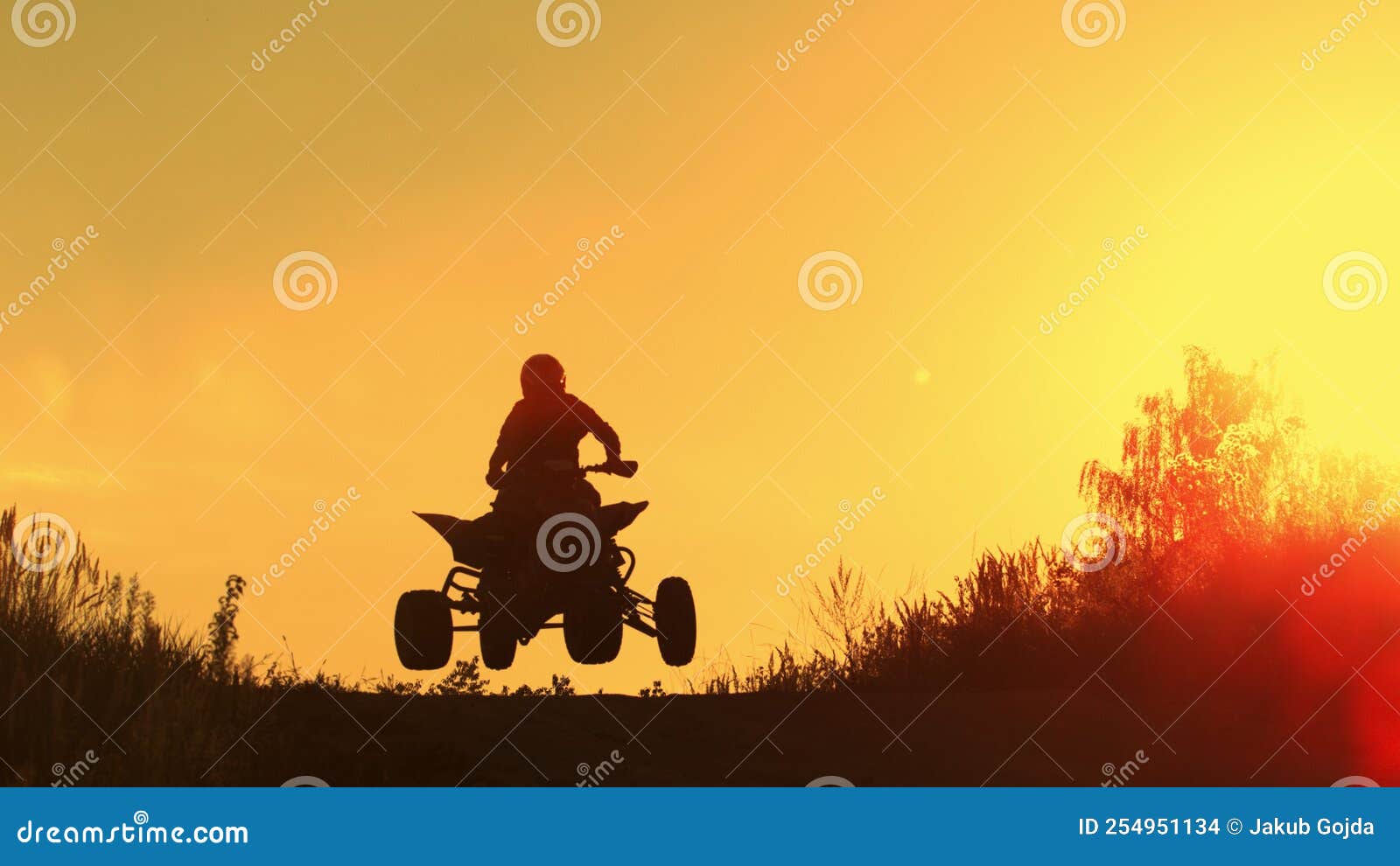 Quad Biker Jumping in Sunset Stock Photo - Image of terrain, silhouette ...