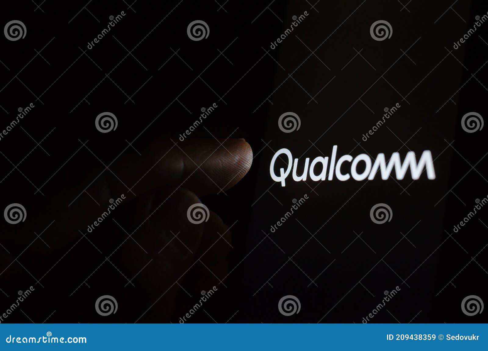 Qualcomm Chip Design Company Logo on a Glowing Screen and a Hand ...