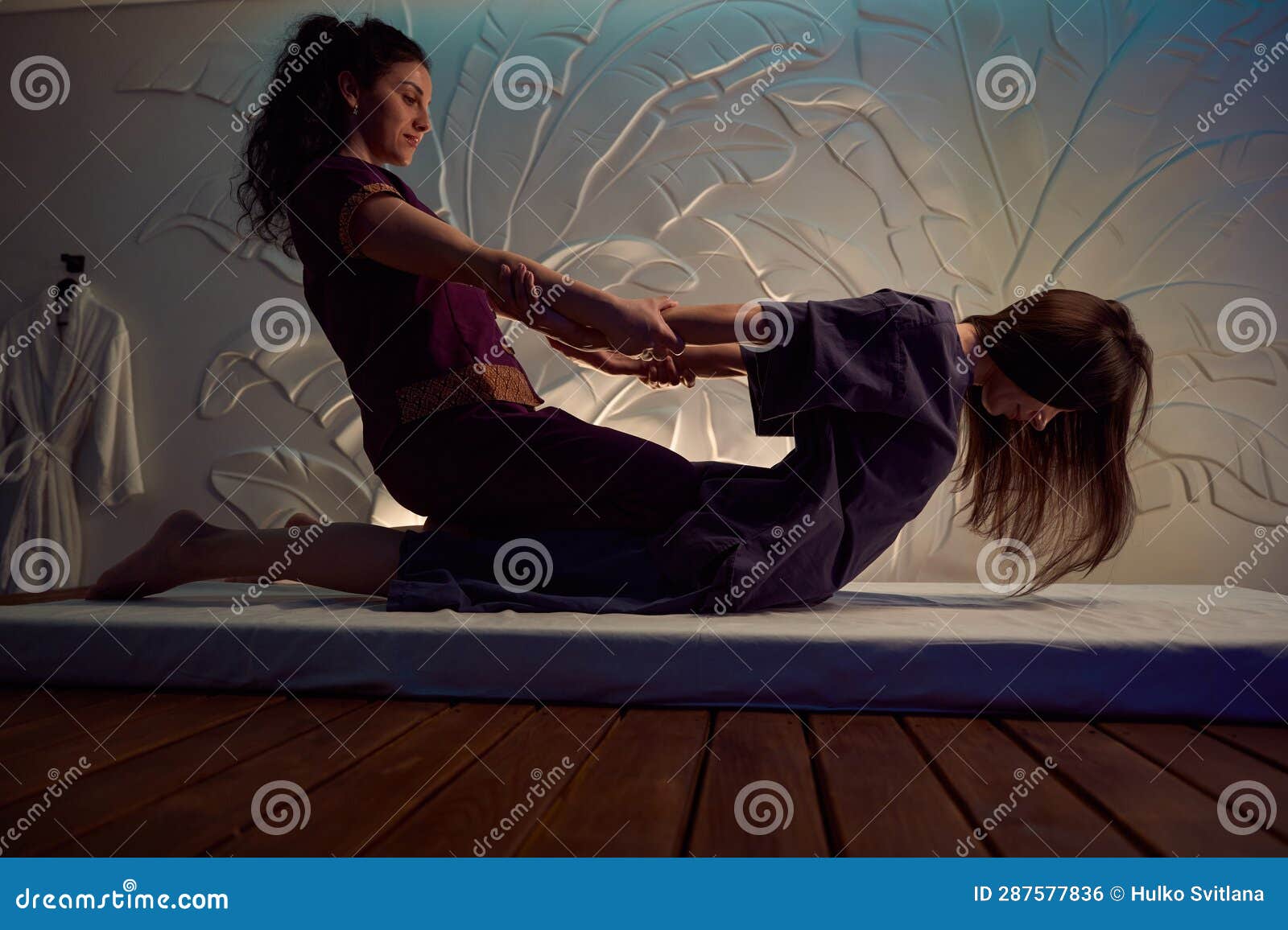 Qualified Masseuse Applying Cobra Spinal Stretch Technique on Female Client Stock Photo - Image ...