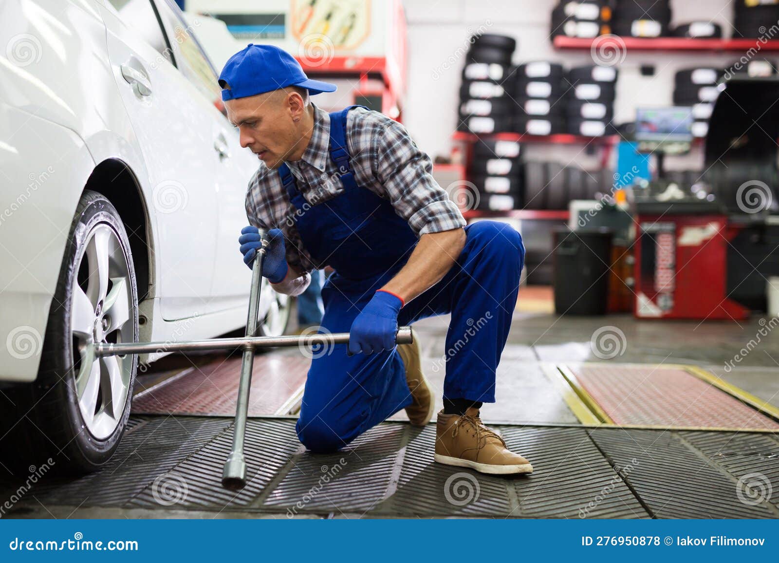 Qualified Mechanic Changes Tires on Car in Car Service Stock Photo ...