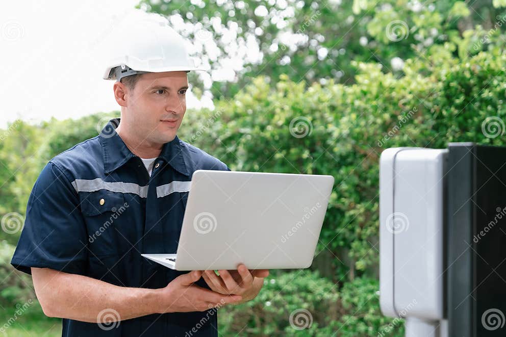 Qualified Technician Working with Laptop for Home EV Station ...