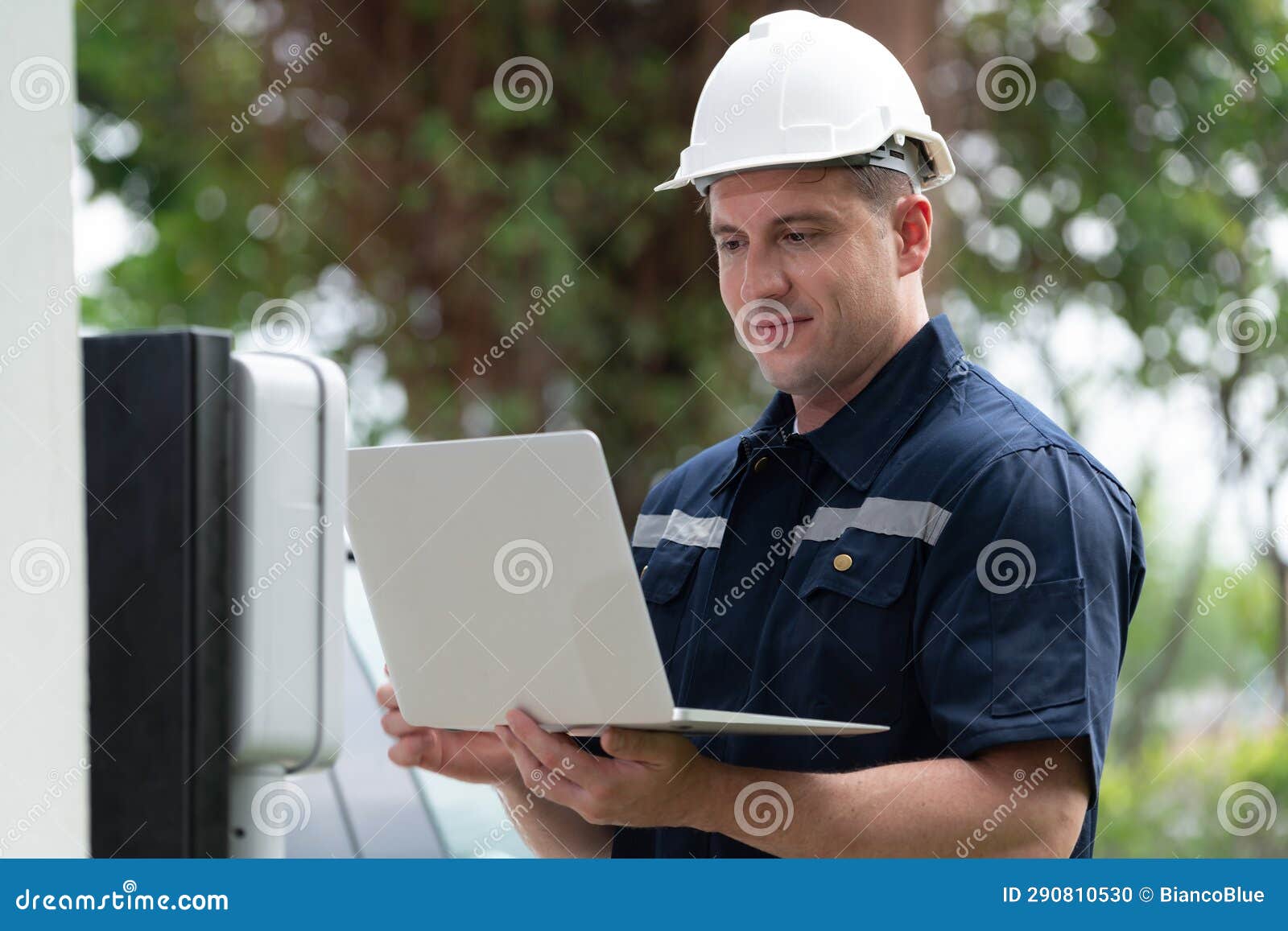 Qualified Technician Working with Laptop for Home EV Station ...