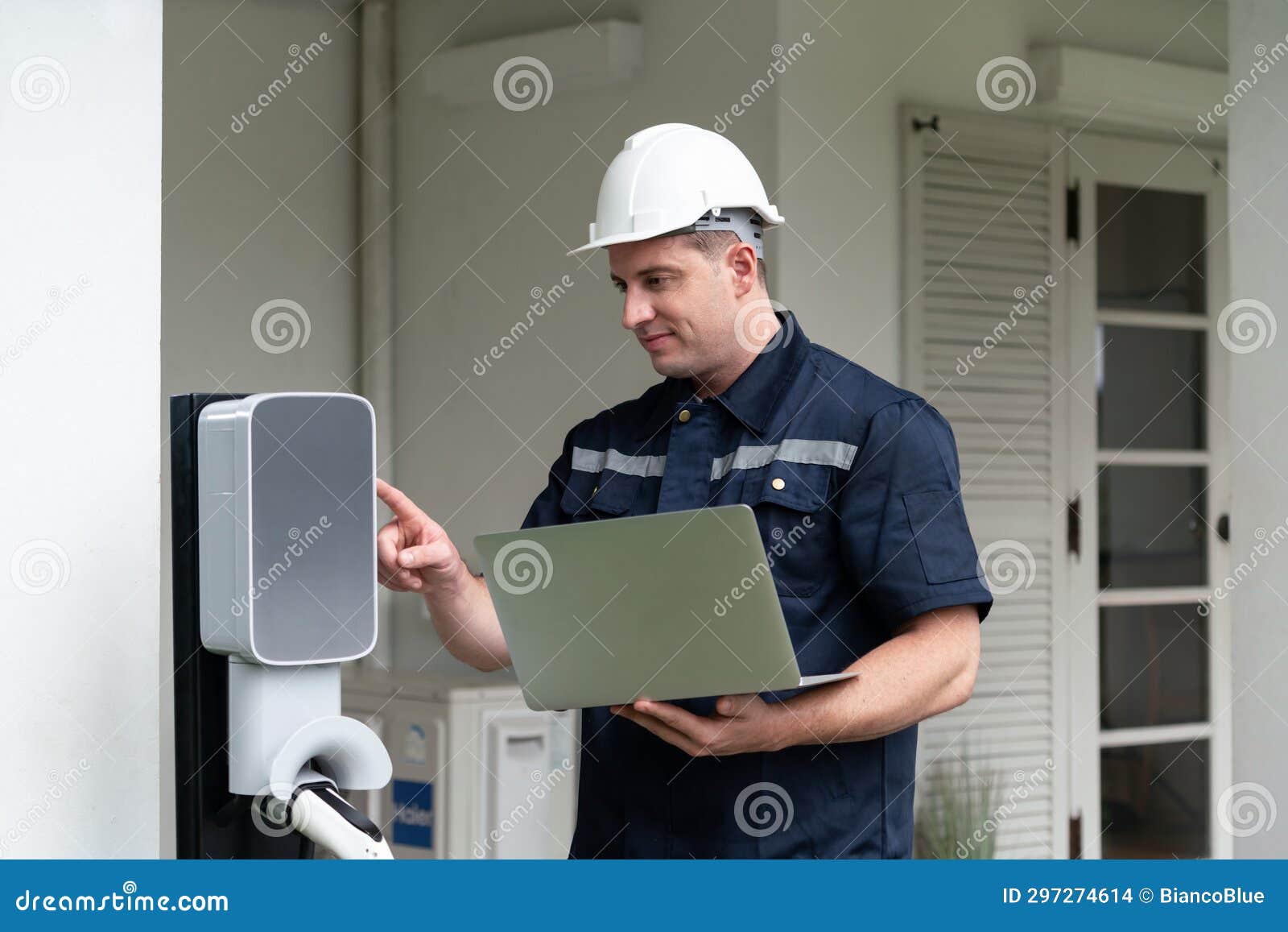 Qualified Technician Working with Laptop for Home EV Station ...