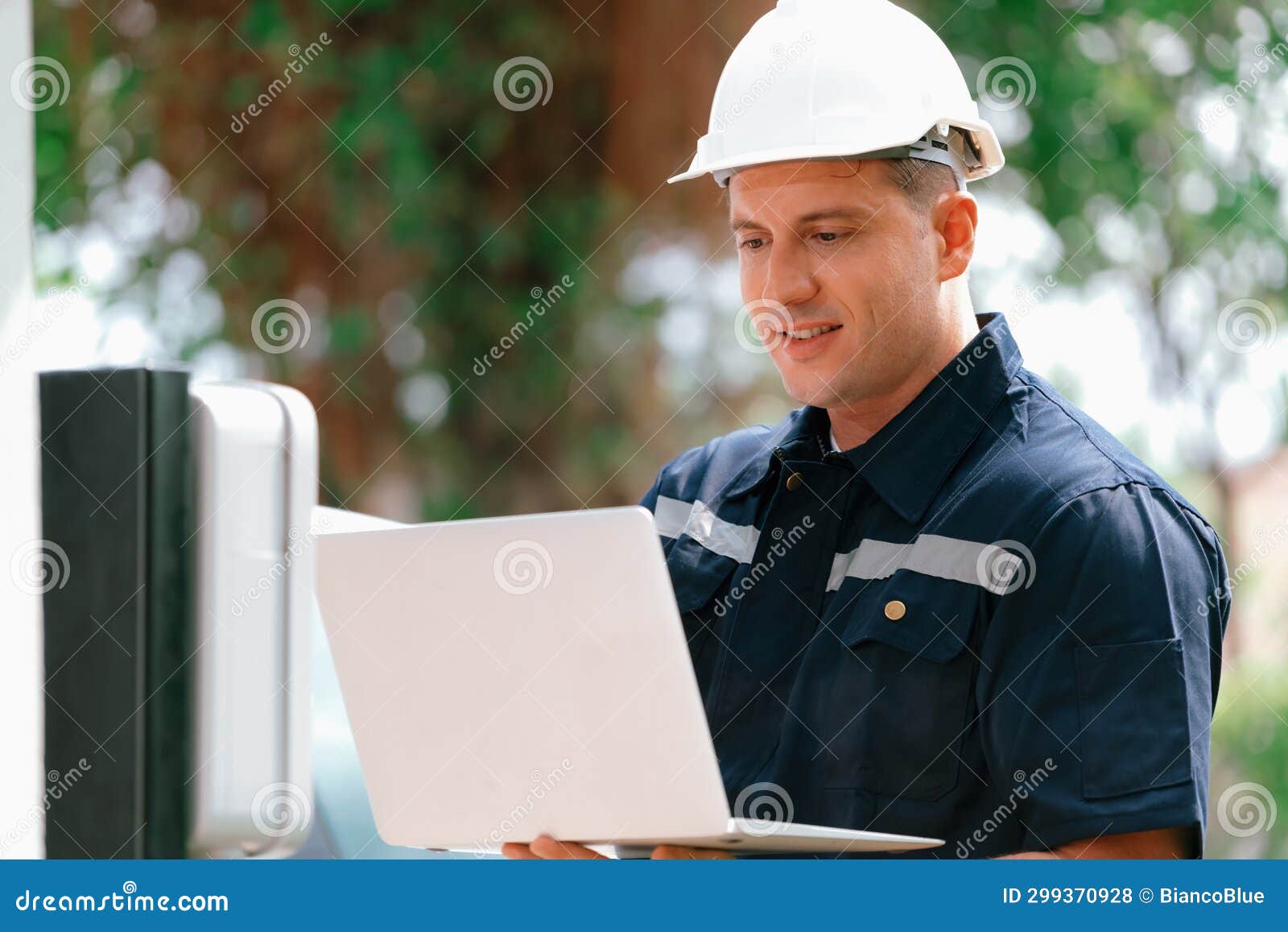 Qualified Technician Working with Laptop for Home EV Station ...